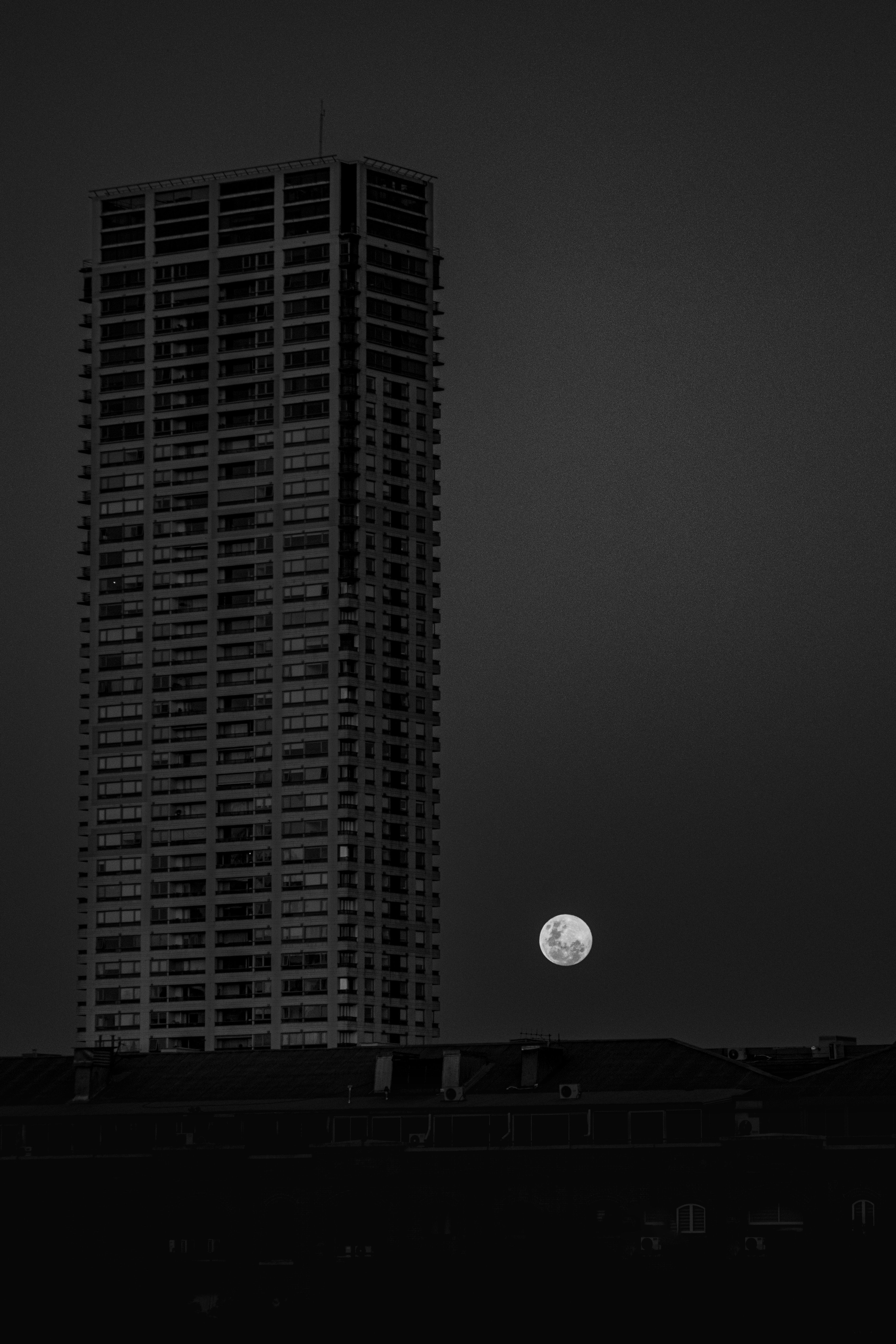 Moon behind Residential Building in City · Free Stock Photo