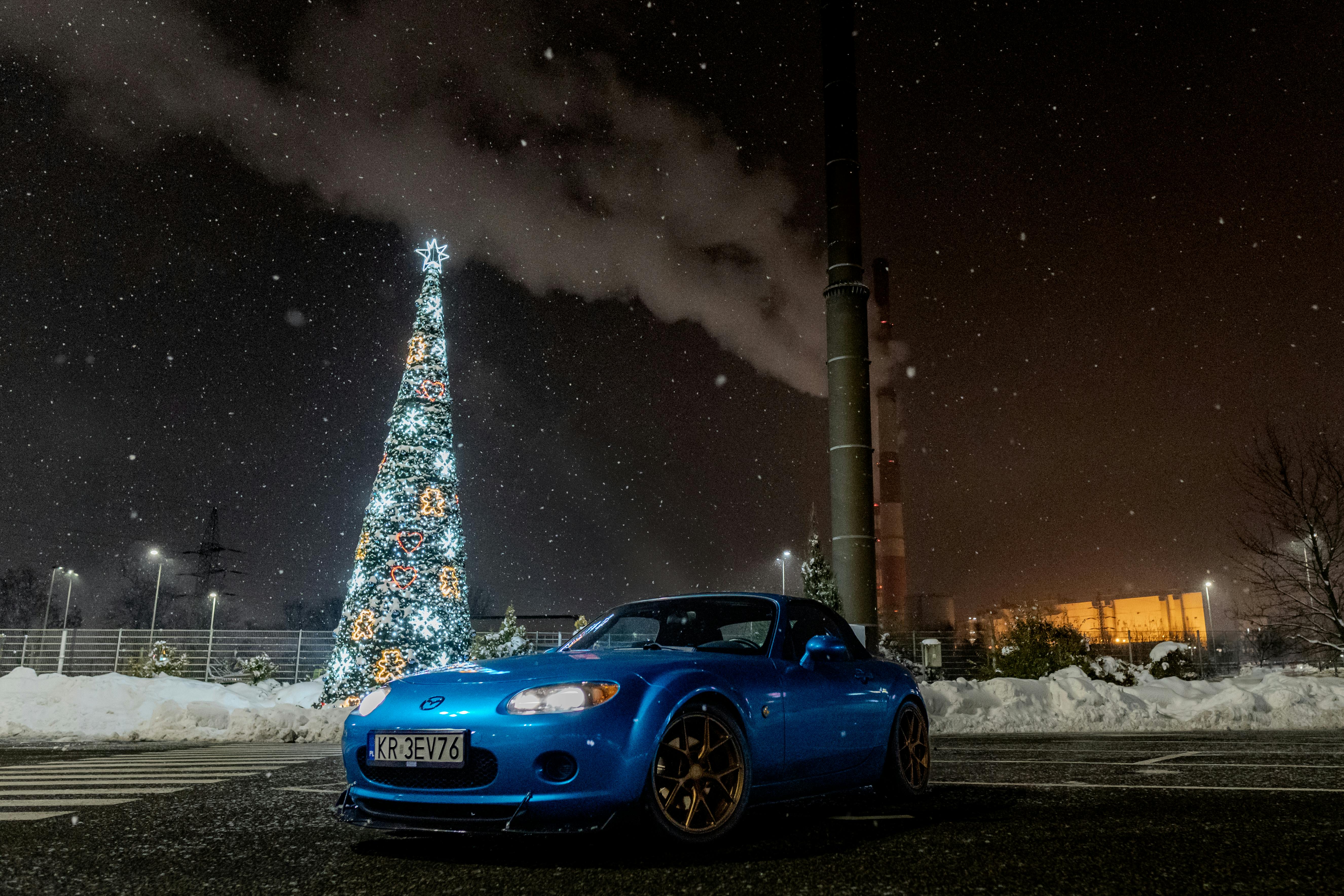 Mazda MX-5 near Factory and Christmas Tree at Night · Free Stock Photo