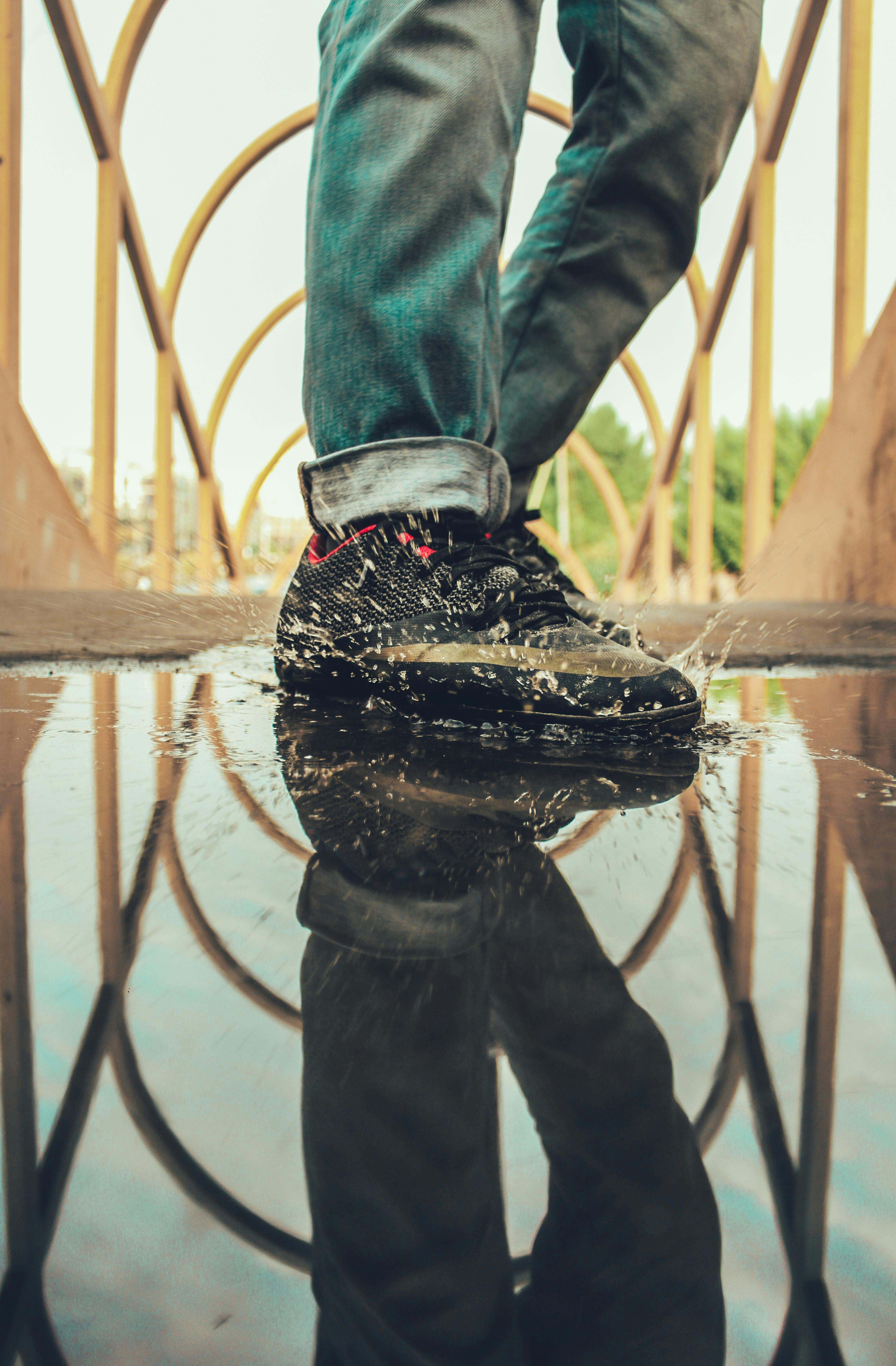 Man Jumping On Puddle Of Water · Free Stock Photo