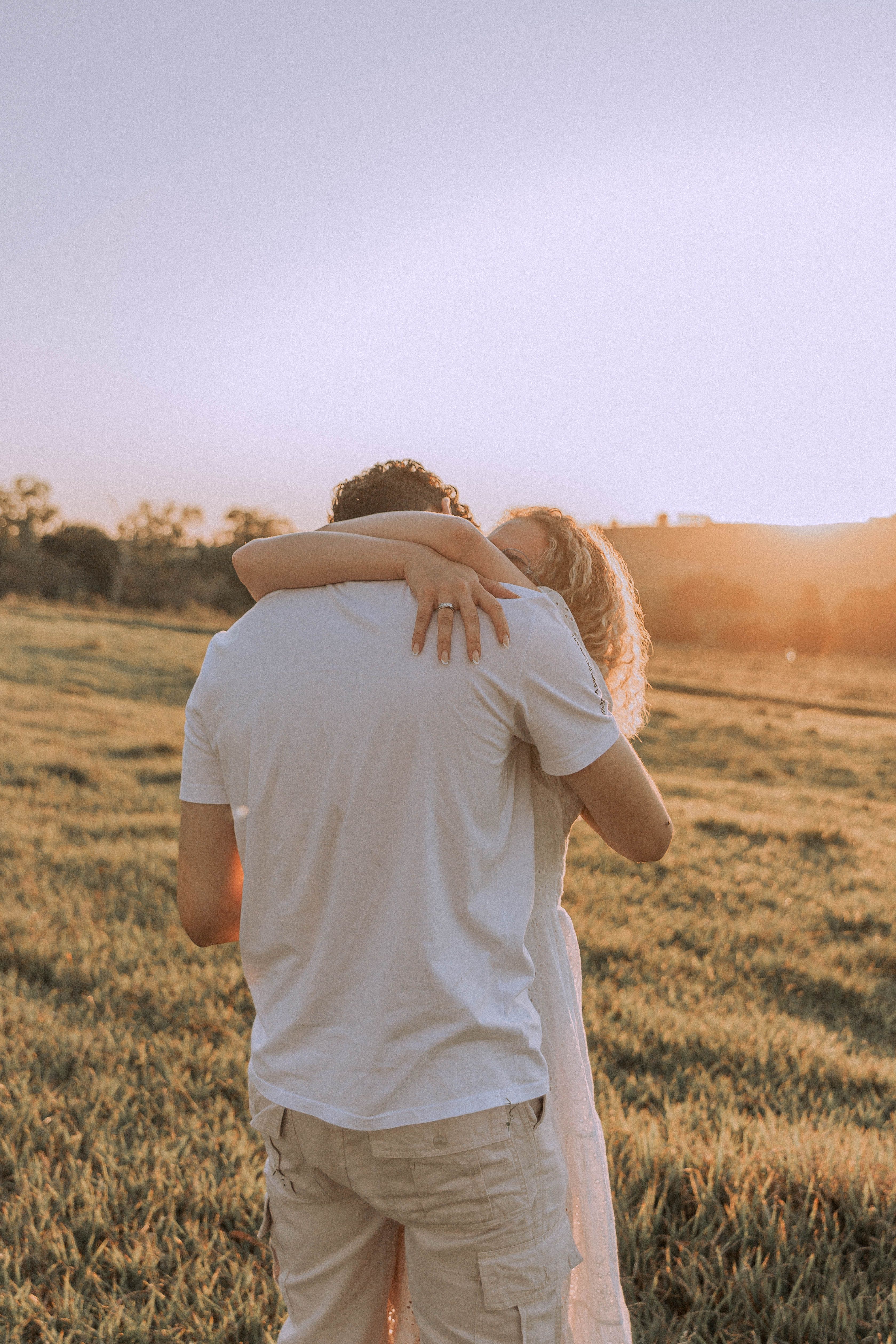 A Couple Hugging in a Field · Free Stock Photo