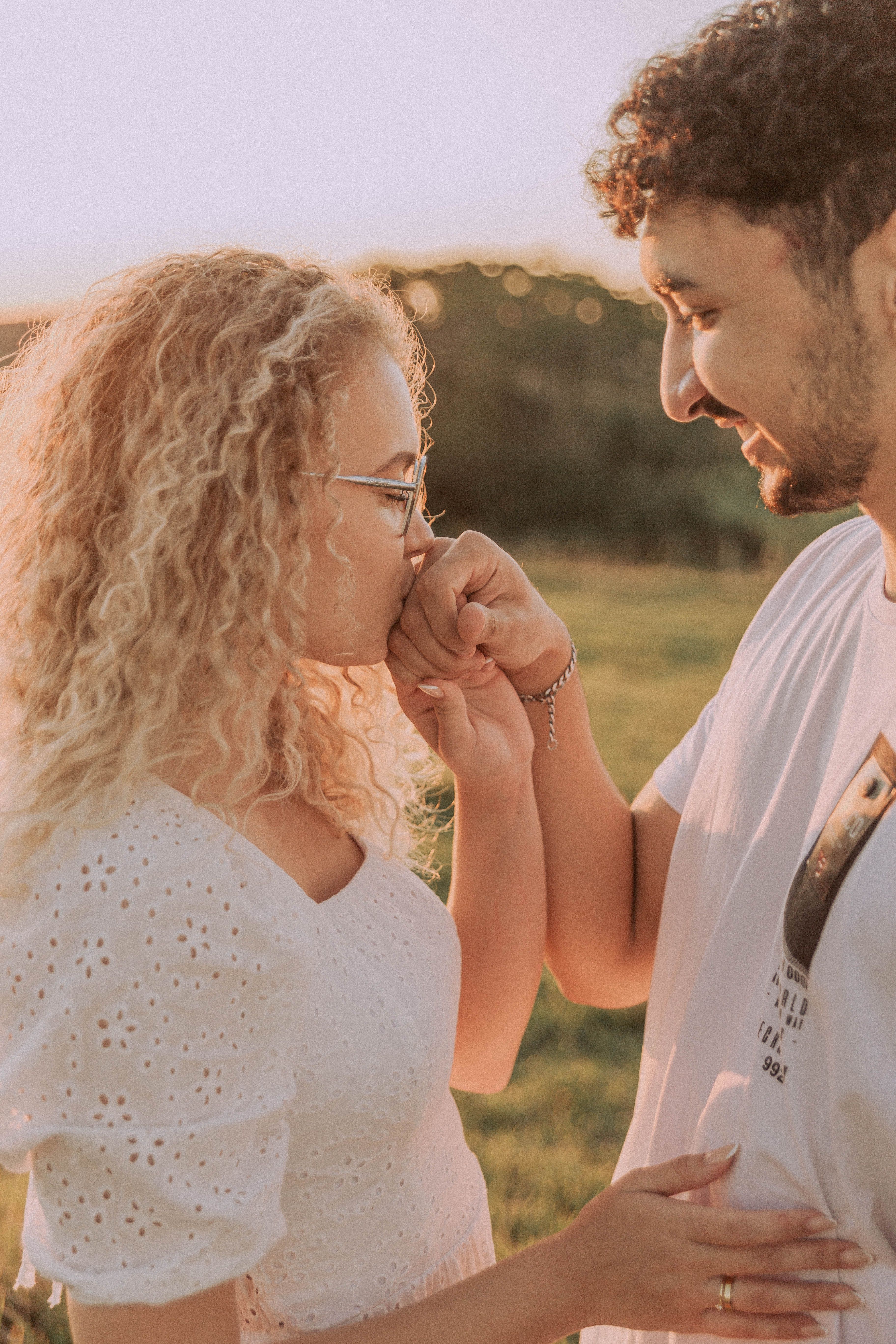 Portrait of Couple Kissing Hands · Free Stock Photo