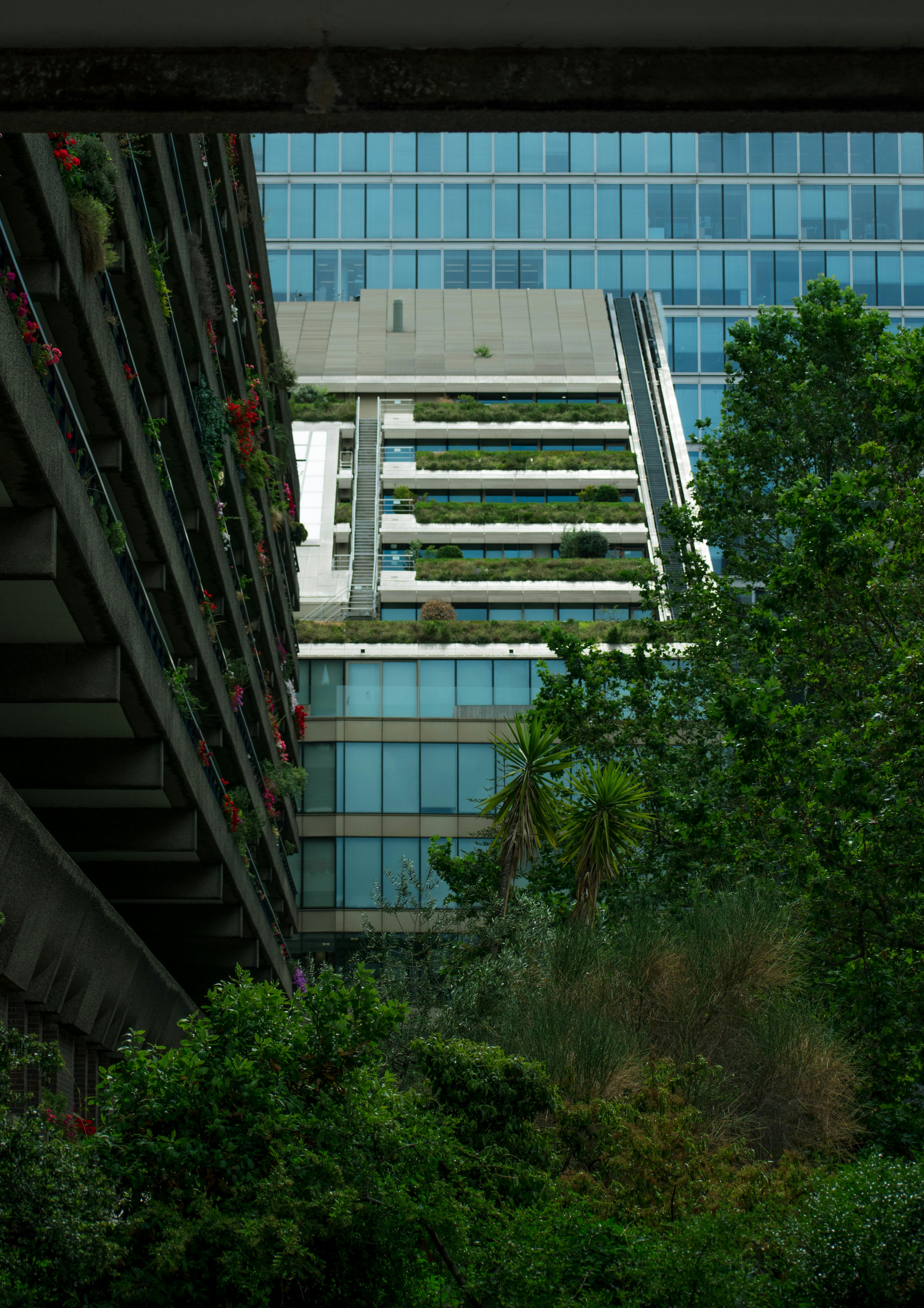 Concrete Brutalist Building with Green Plants Growing on Balconies ...
