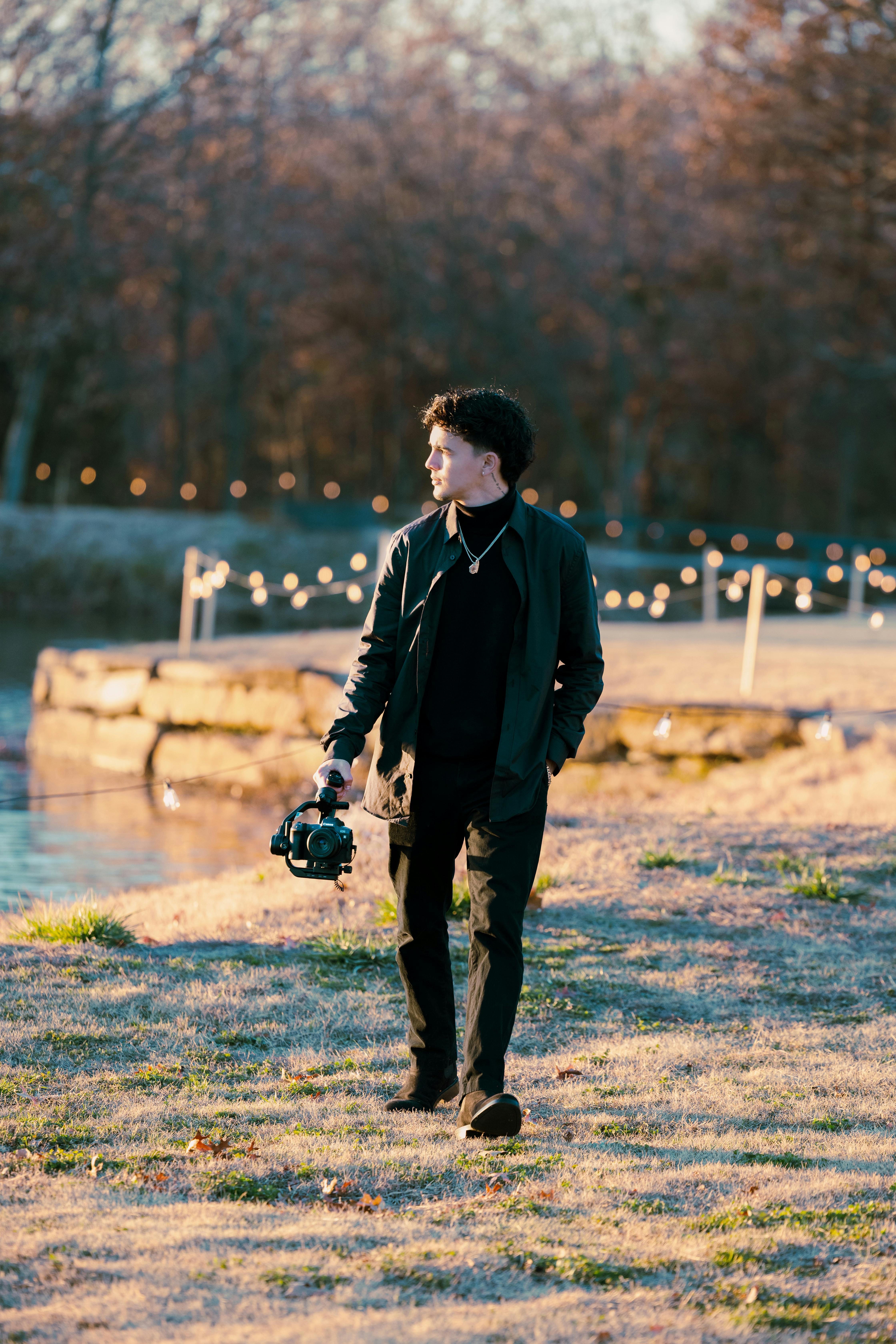 Photographer Carrying Camera in Autumn Park · Free Stock Photo