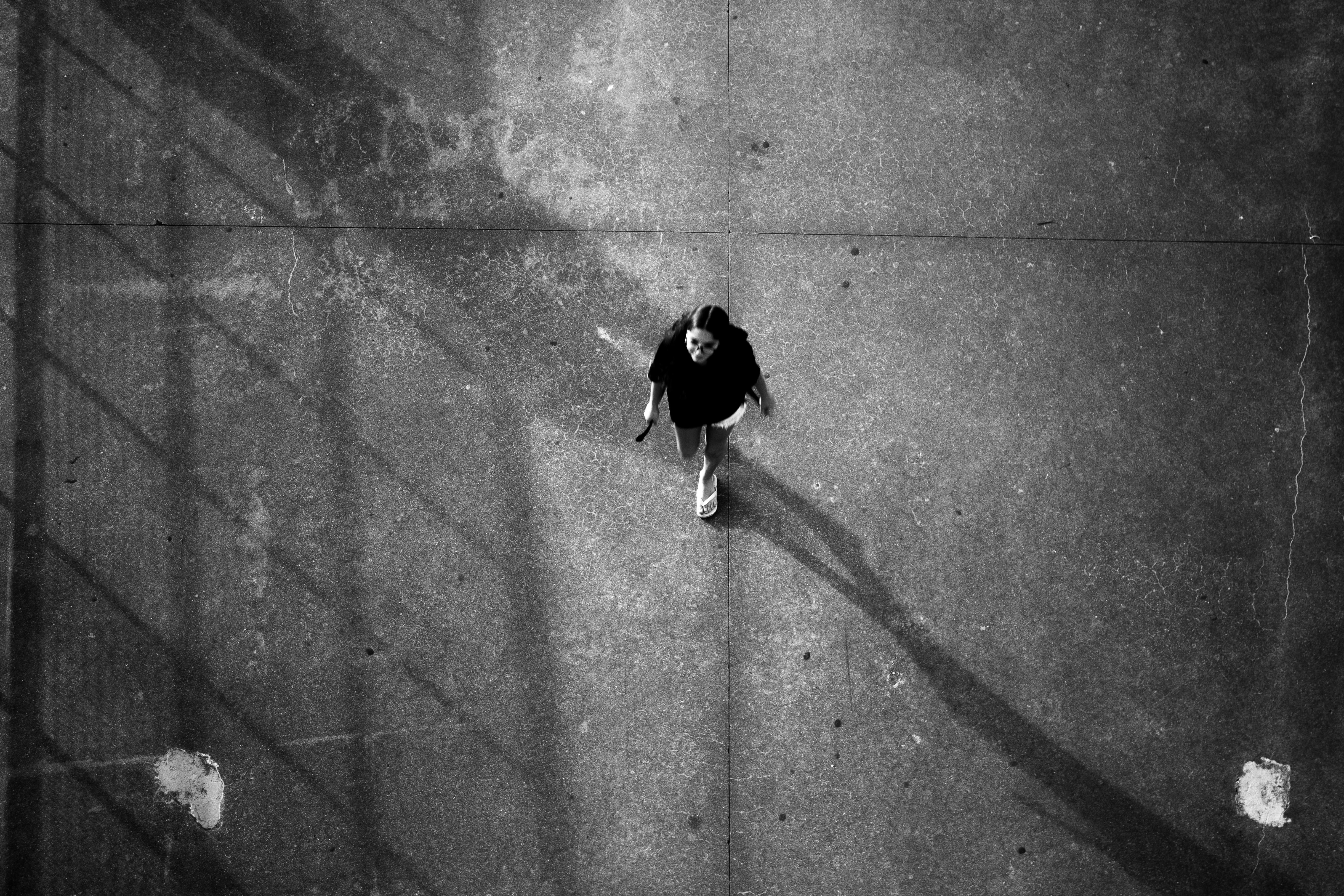 Top View of a Pedestrian Walking on a Pavement · Free Stock Photo