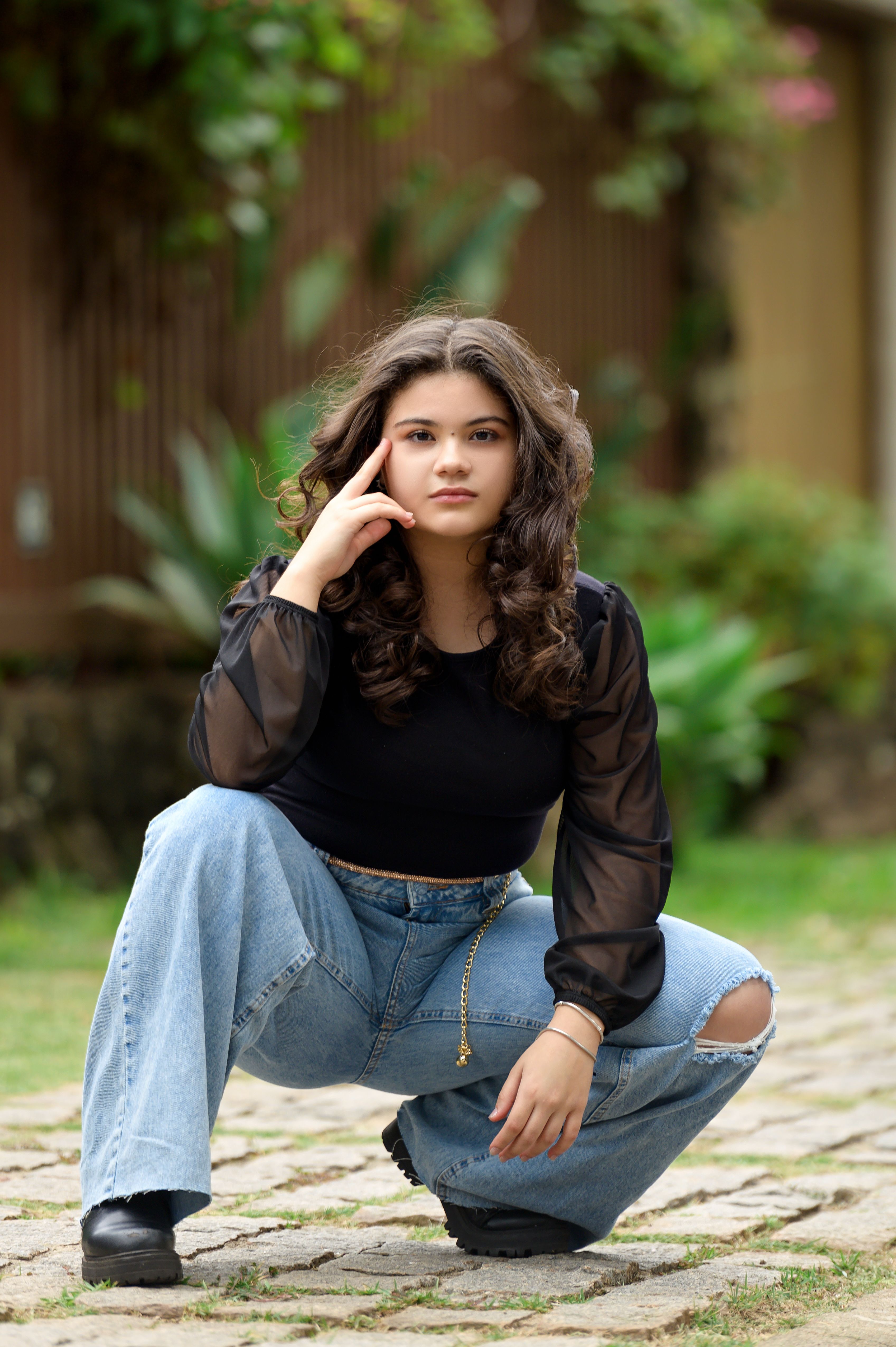 A Smiling Woman Crouching on Pavement · Free Stock Photo