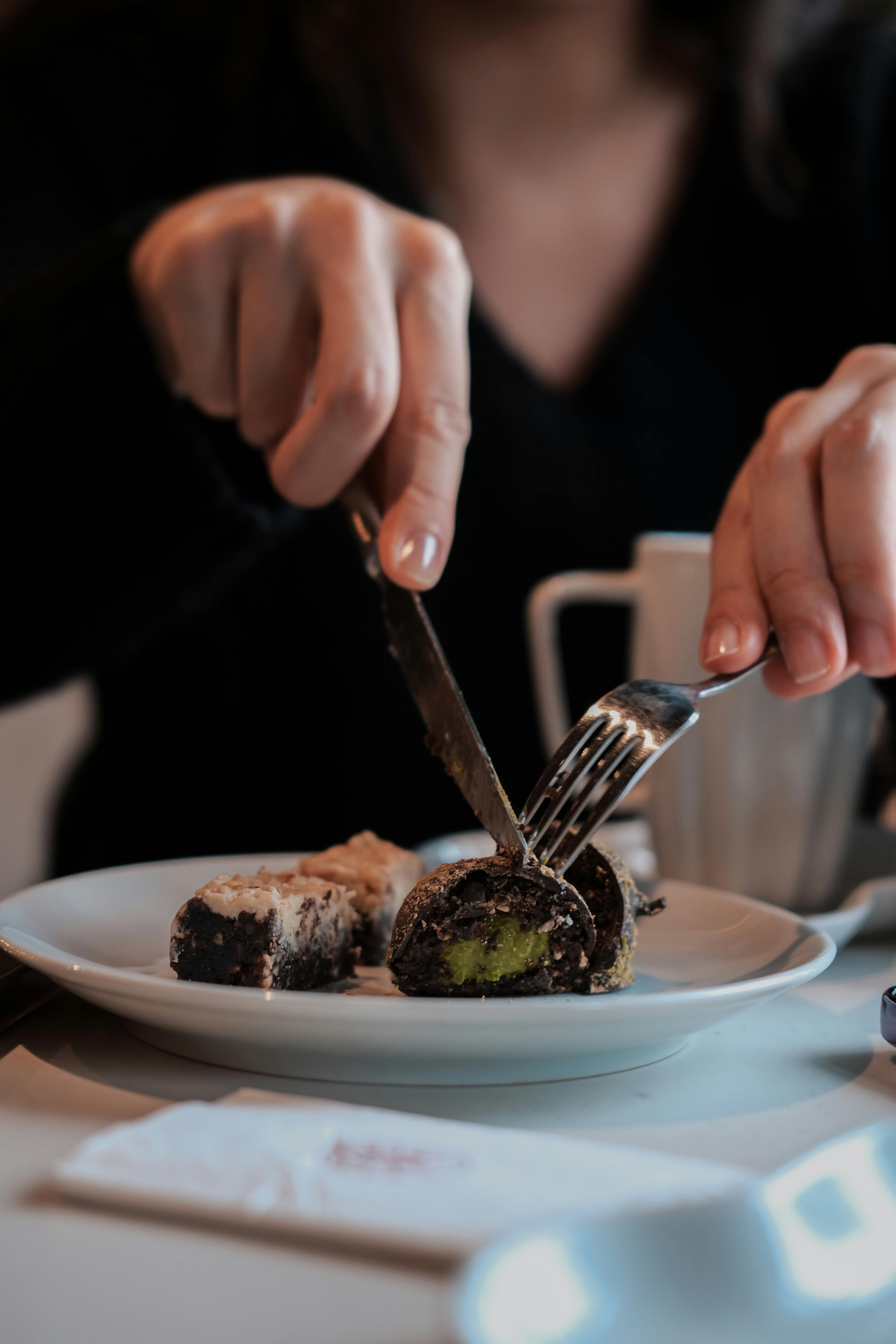 Woman Hands Holding Fork and Knife over Plate with Cake · Free Stock Photo