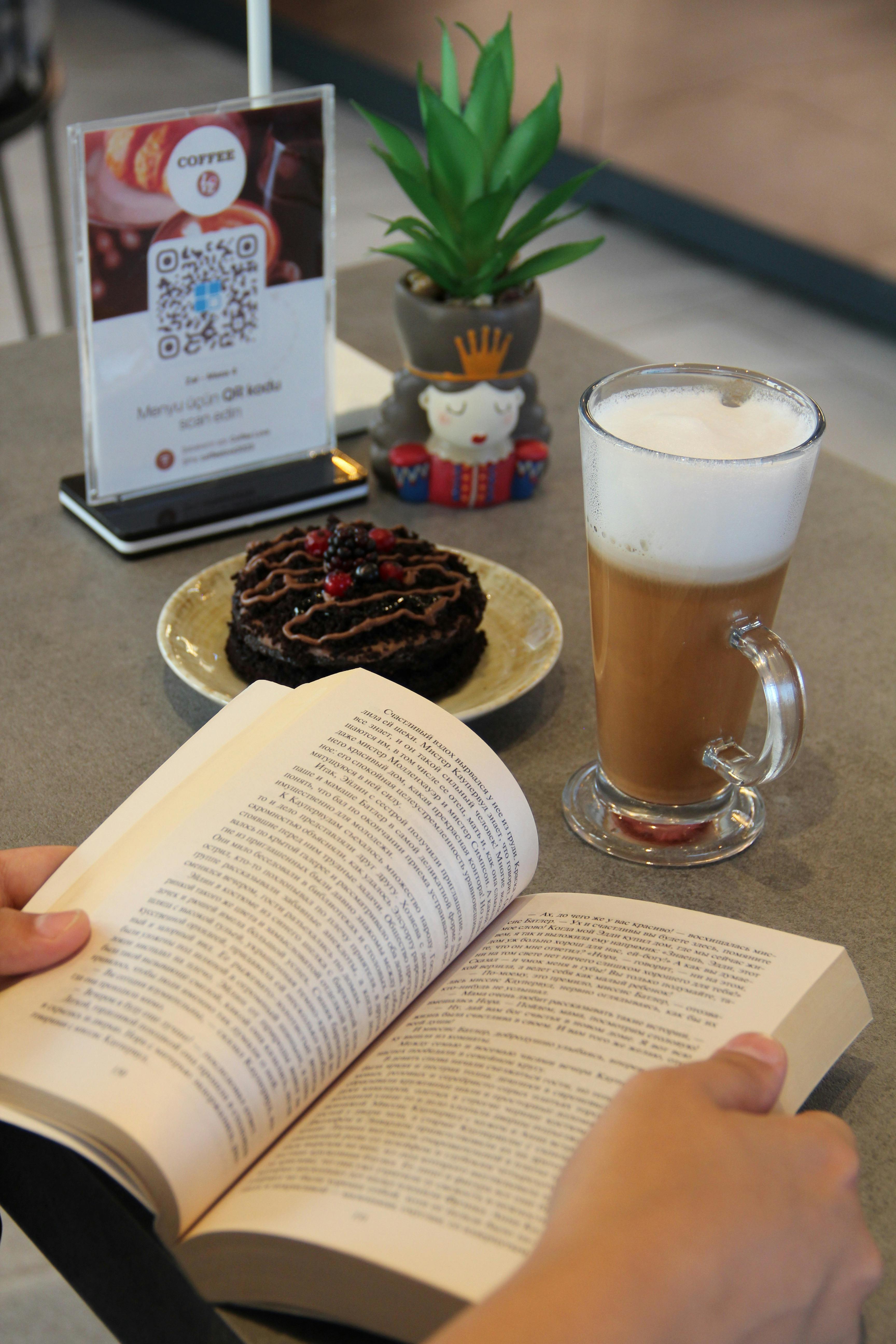 Man Reading Book in a Coffee Shop · Free Stock Photo