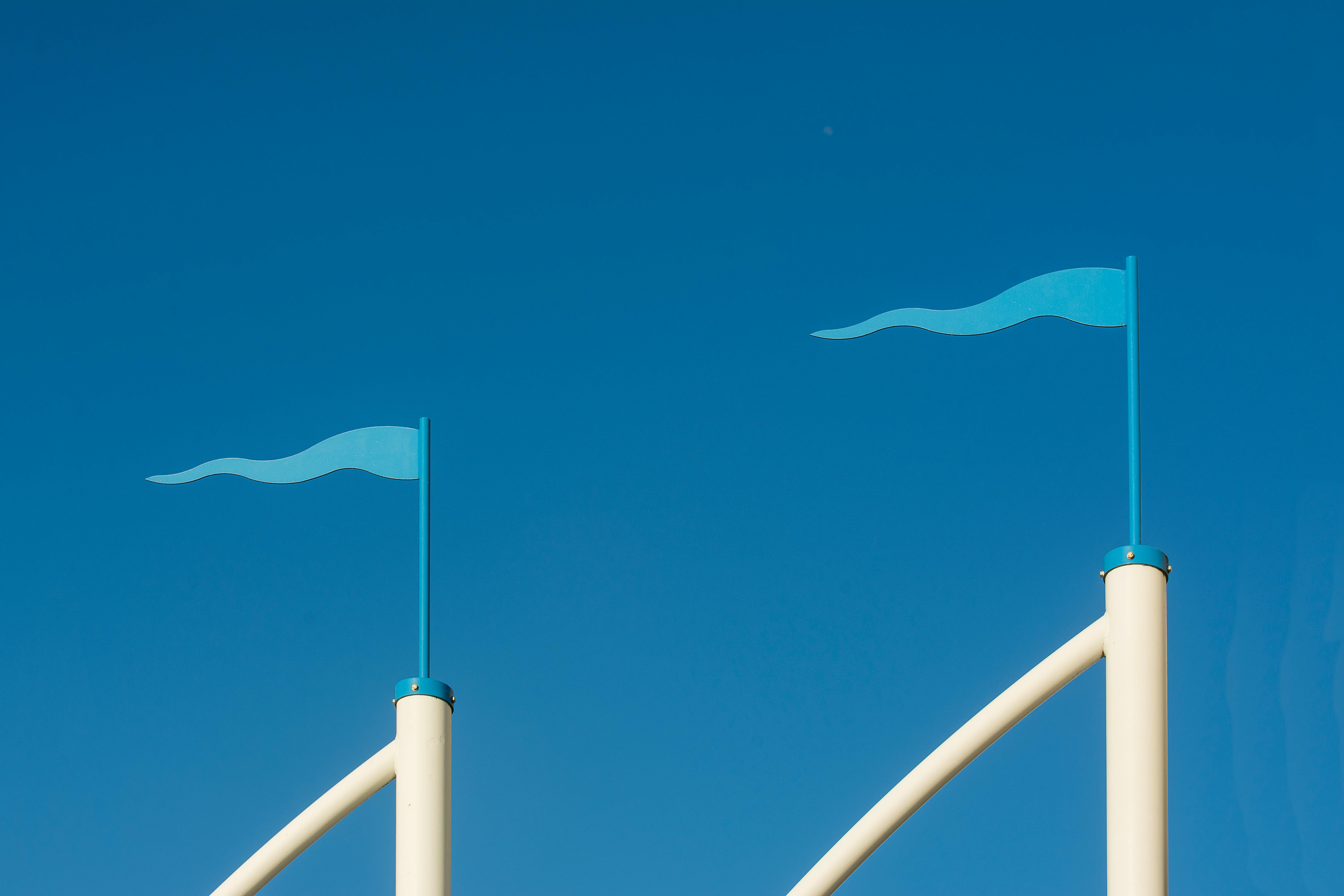 Photo Of Flagpoles During Daytime · Free Stock Photo