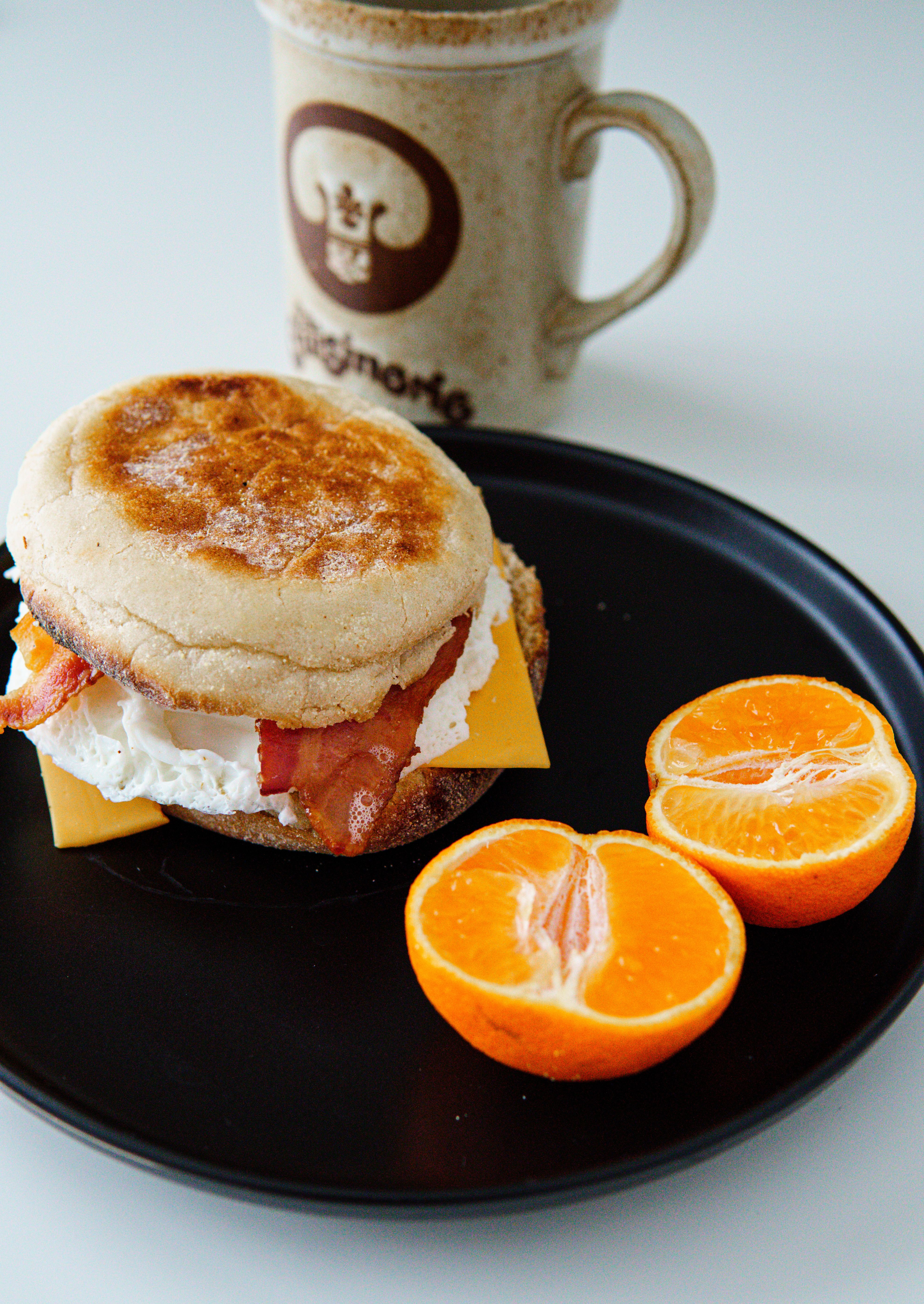 Tangerine Next to an Egg and Bacon Sandwich · Free Stock Photo
