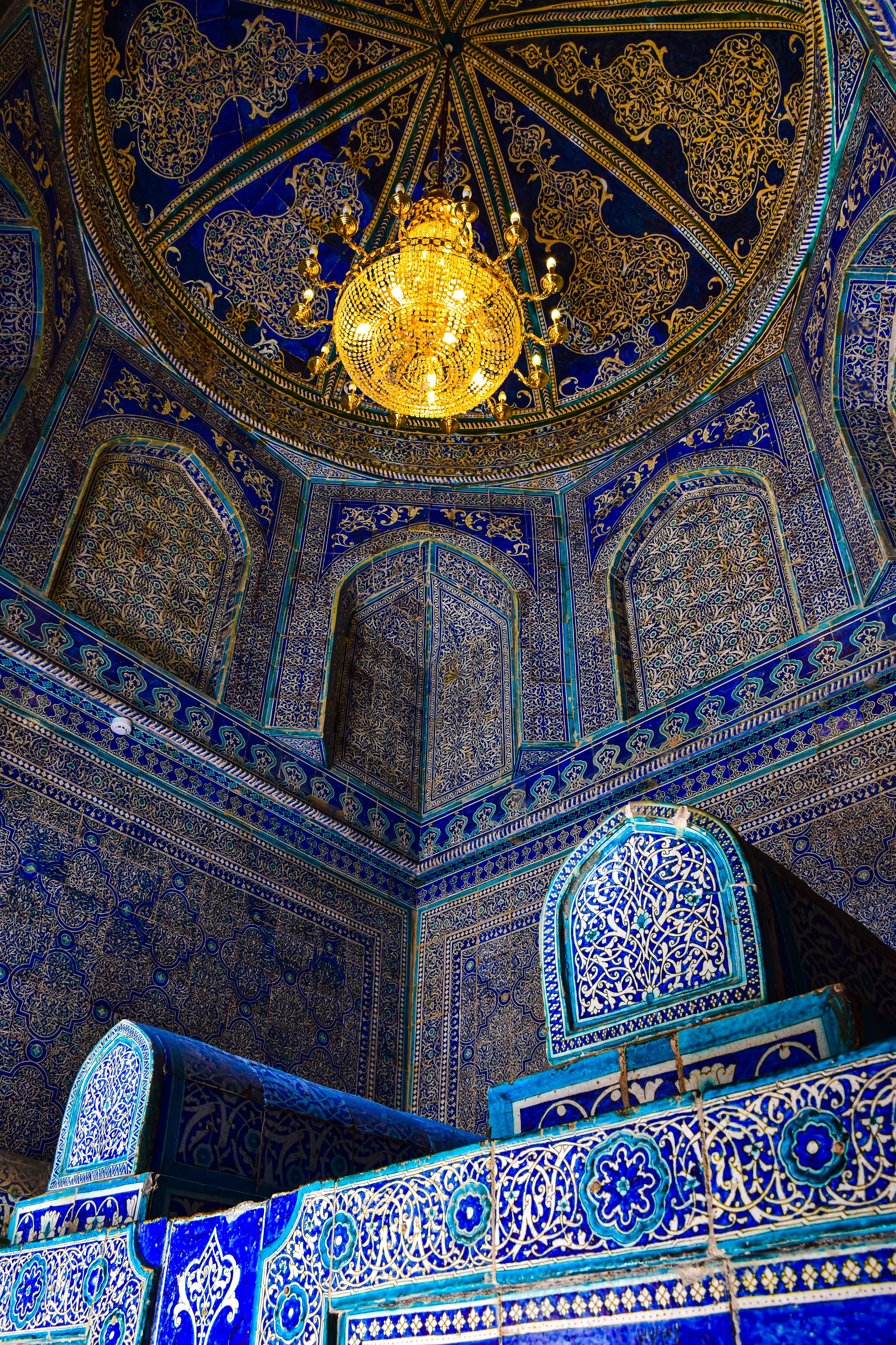 The interior of a mosque with blue and gold decorations · Free Stock Photo