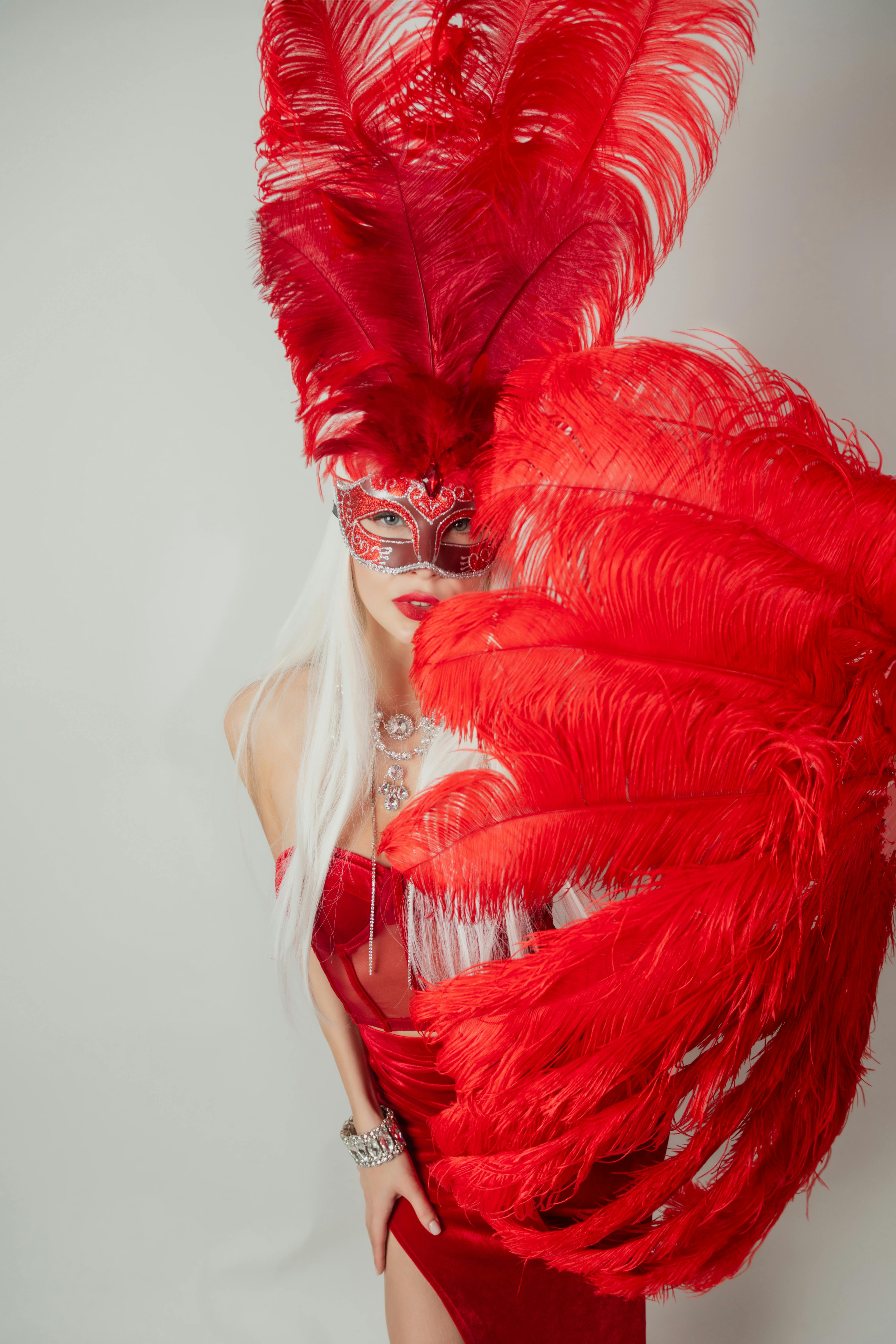 Woman Posing in a Red Costume with Feathers · Free Stock Photo