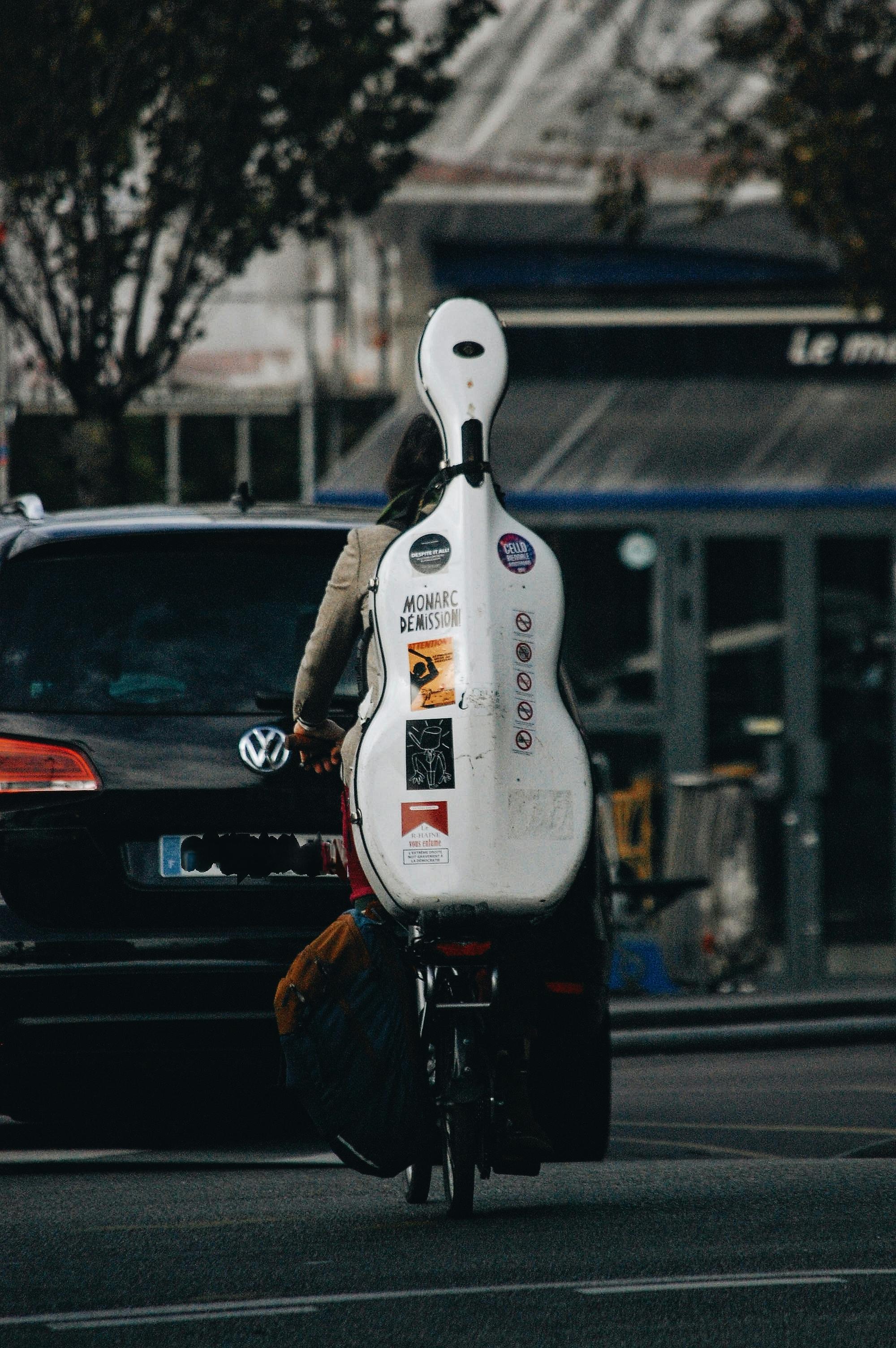 Woman Riding Bike with Cello Case · Free Stock Photo