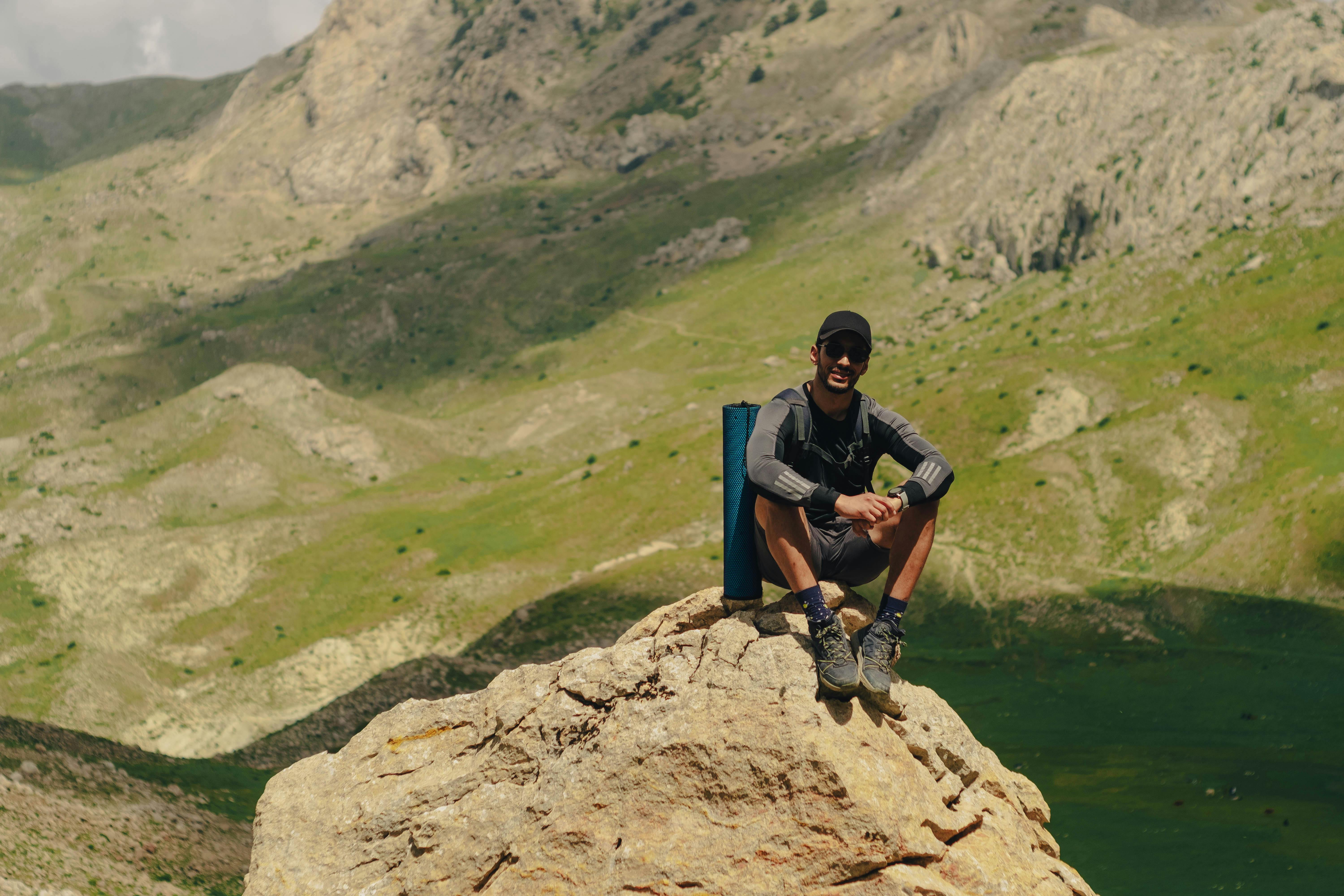 Photo of Woman Sitting on Rock · Free Stock Photo
