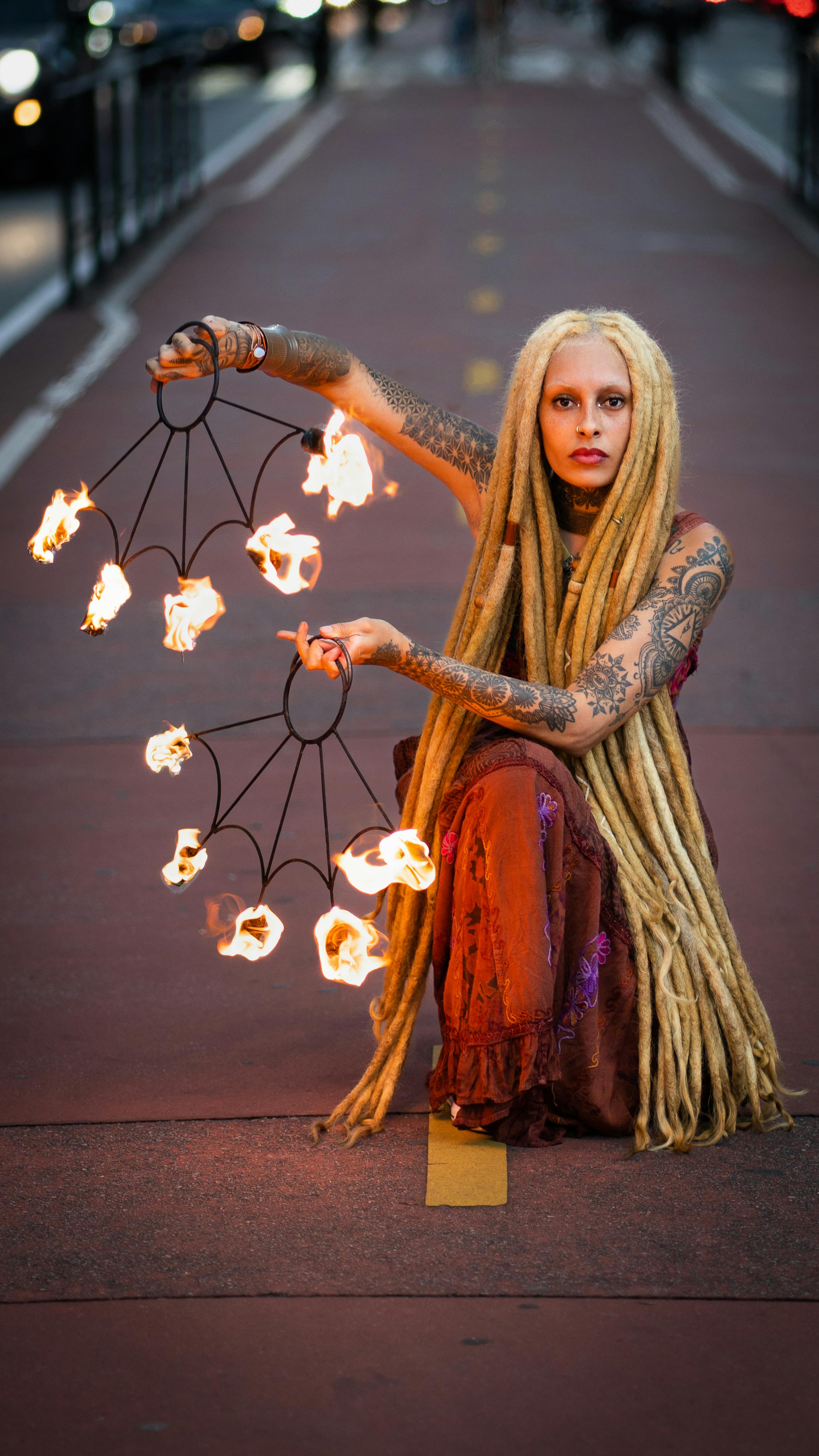 Woman with Tattoos and Dreadlocks in Fire Performance · Free Stock Photo