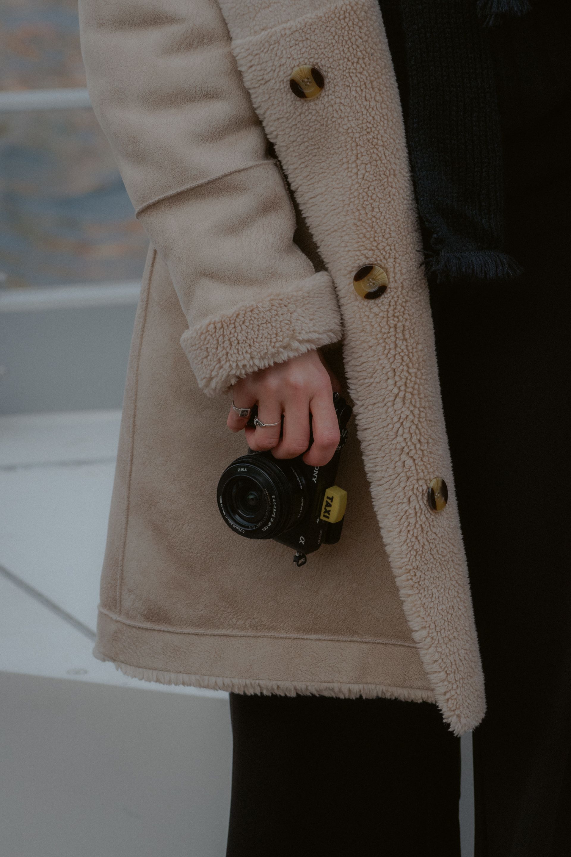 Person in Winter Coat Holding Camera · Free Stock Photo