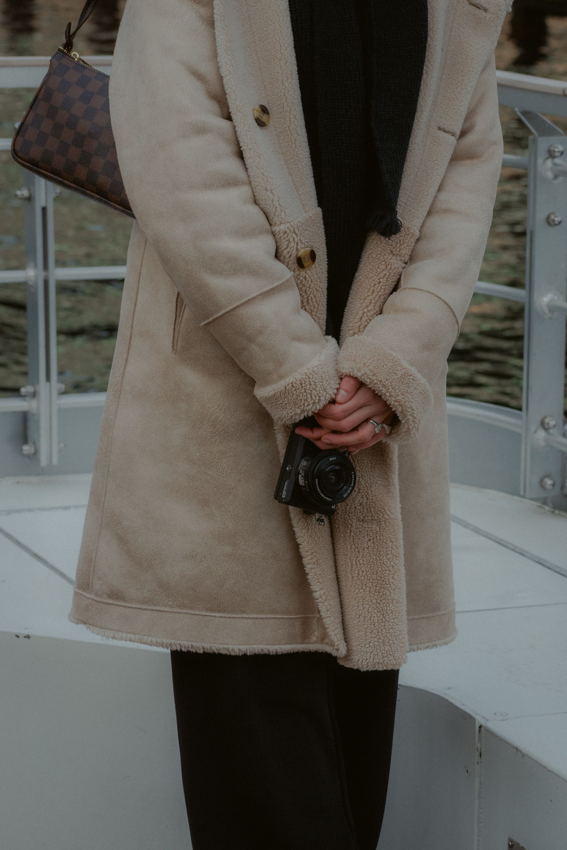 Woman in Winter Coat Holding Camera · Free Stock Photo