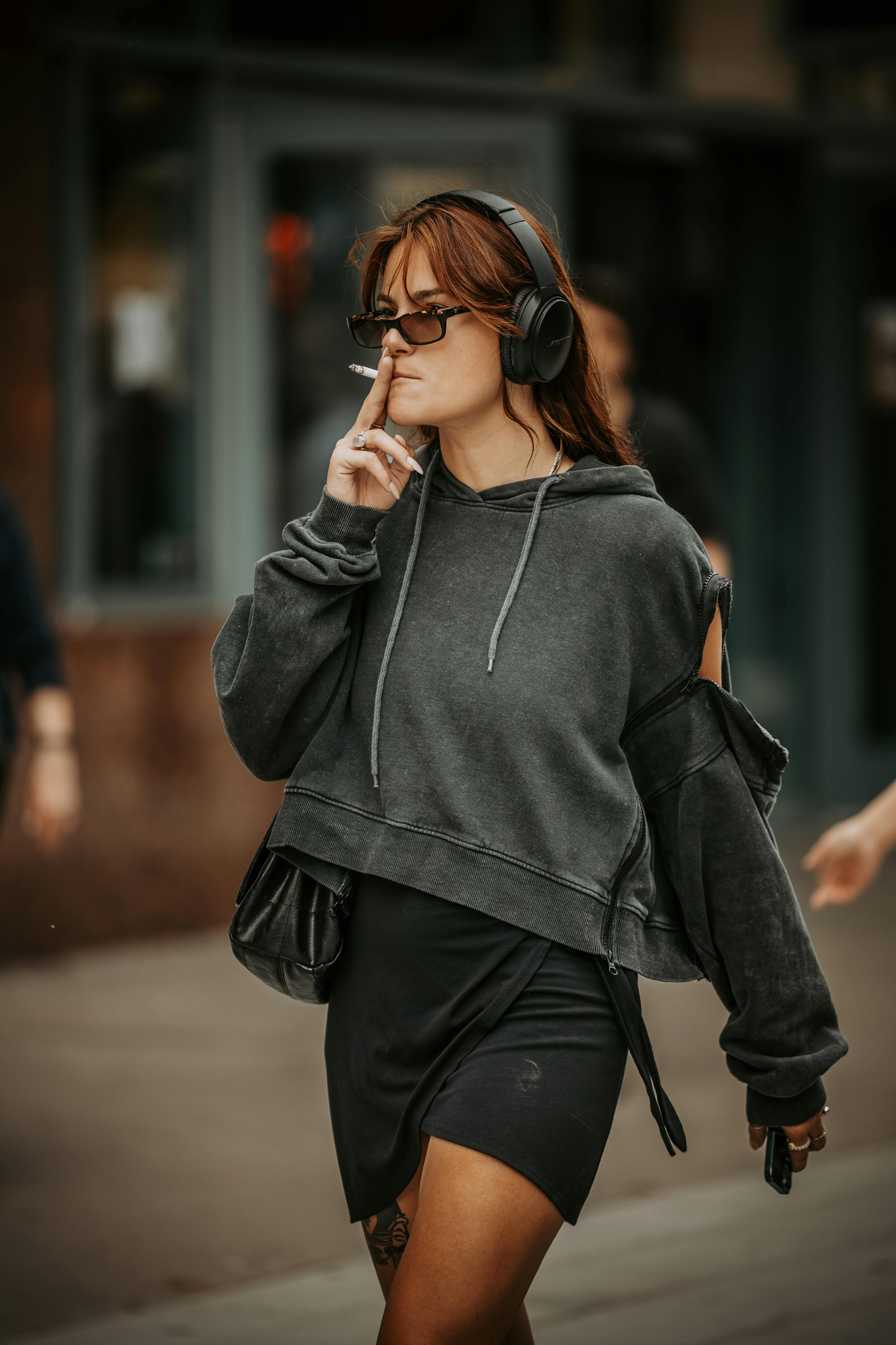 Woman Smoking a Cigarette on a Street · Free Stock Photo