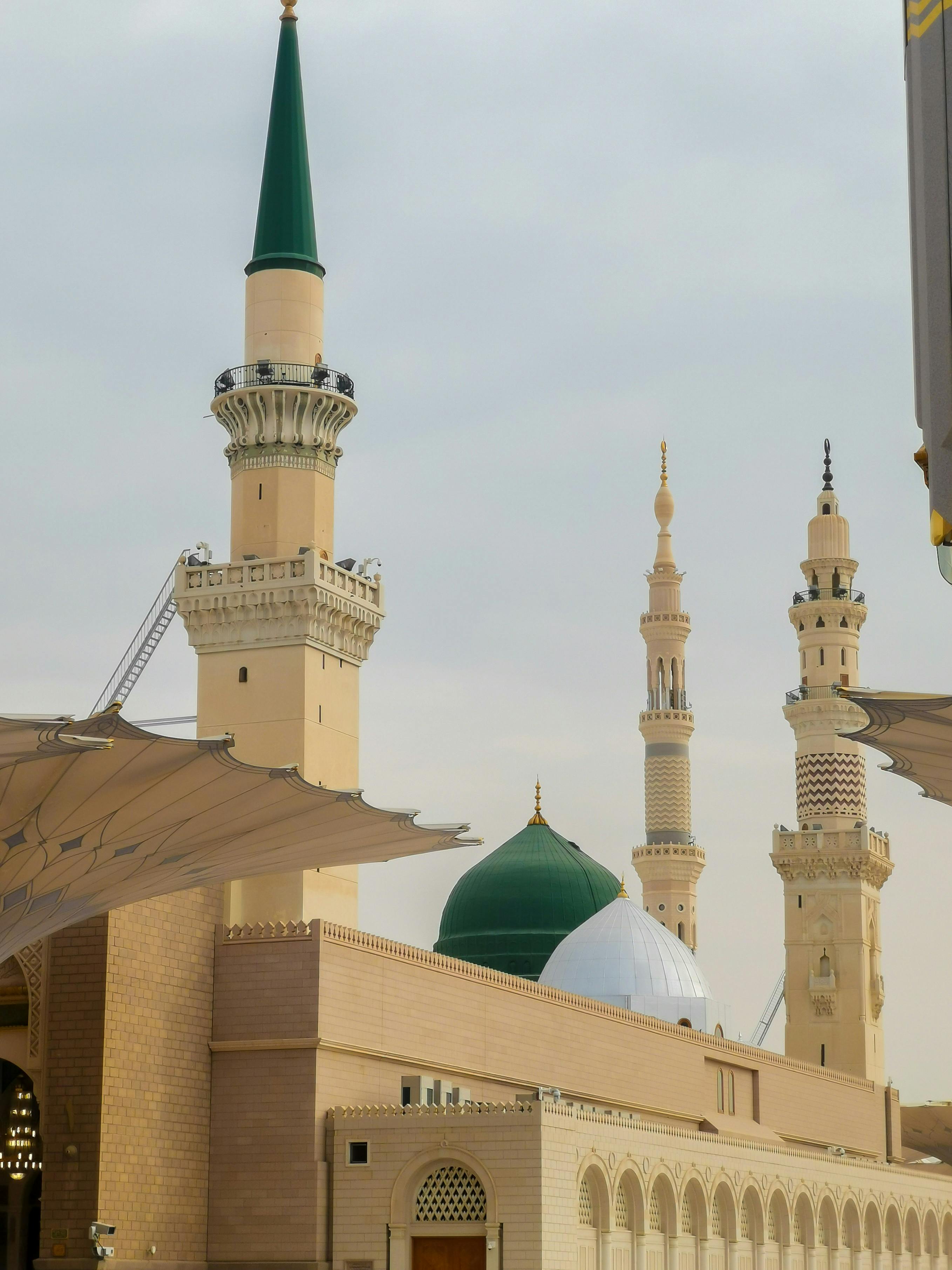 A mosque with two green domes and a white roof · Free Stock Photo