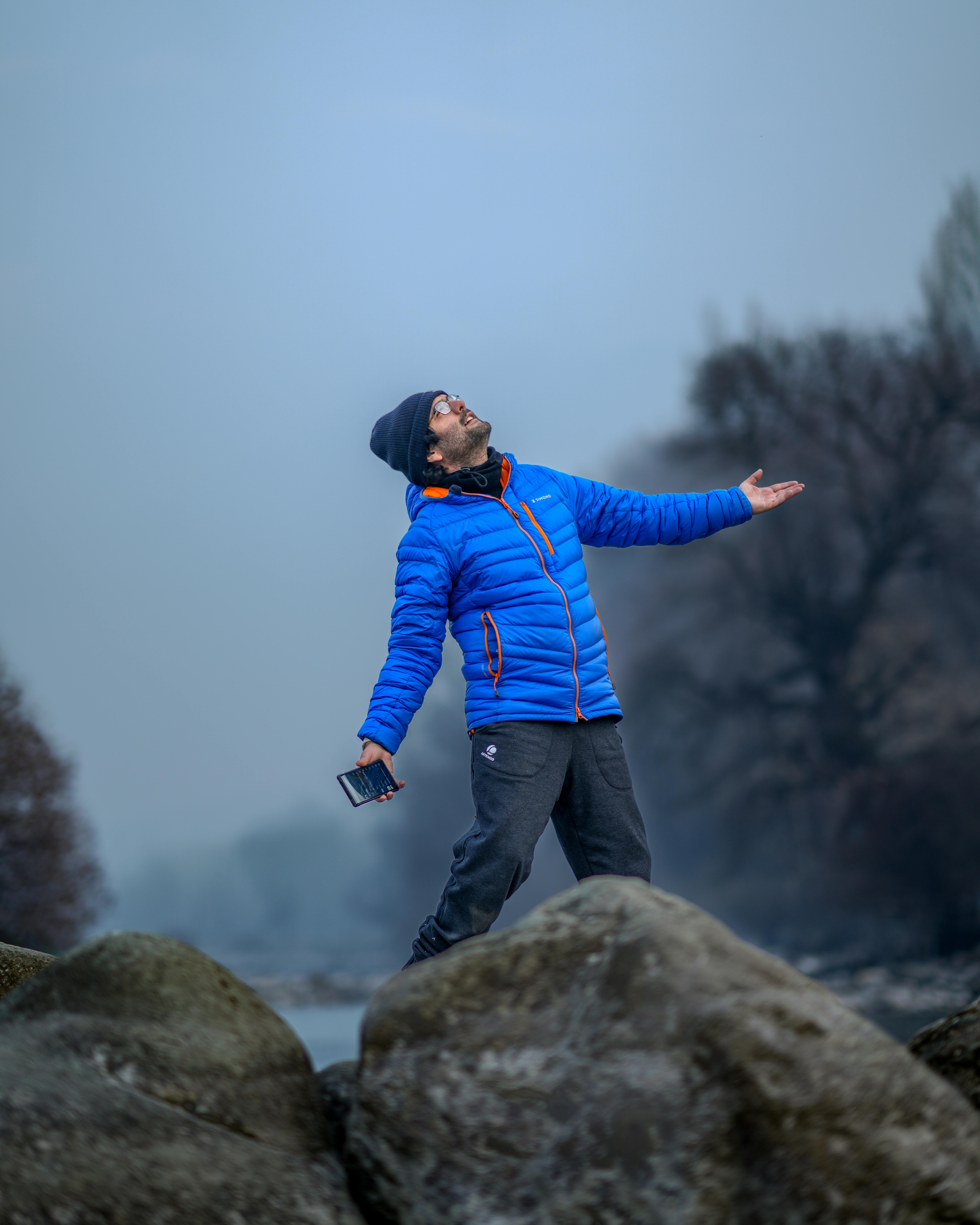 Man Wearing Blue Jacket in a Rocky Valley · Free Stock Photo