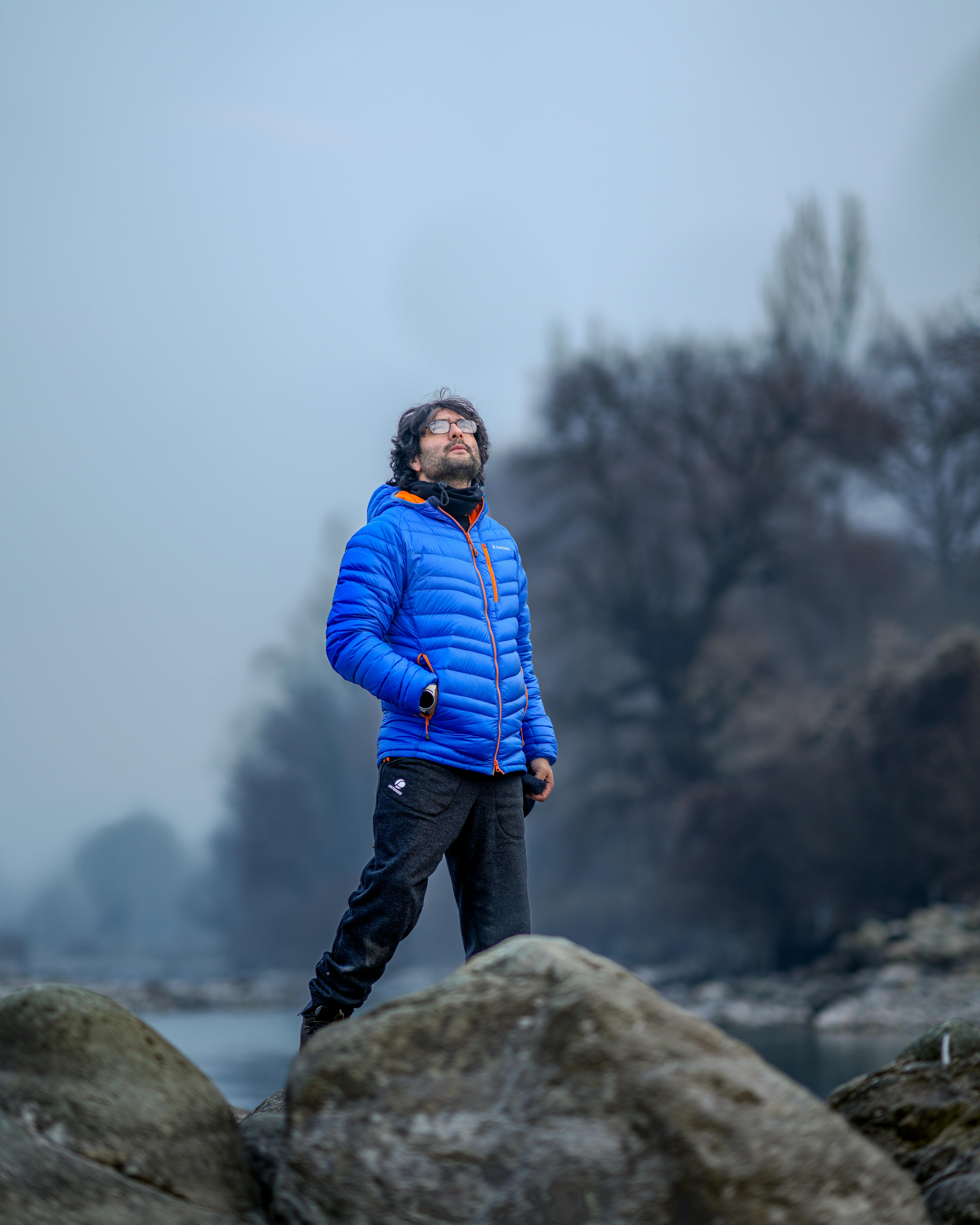 Man Wearing Blue Jacket in a Rocky Valley · Free Stock Photo