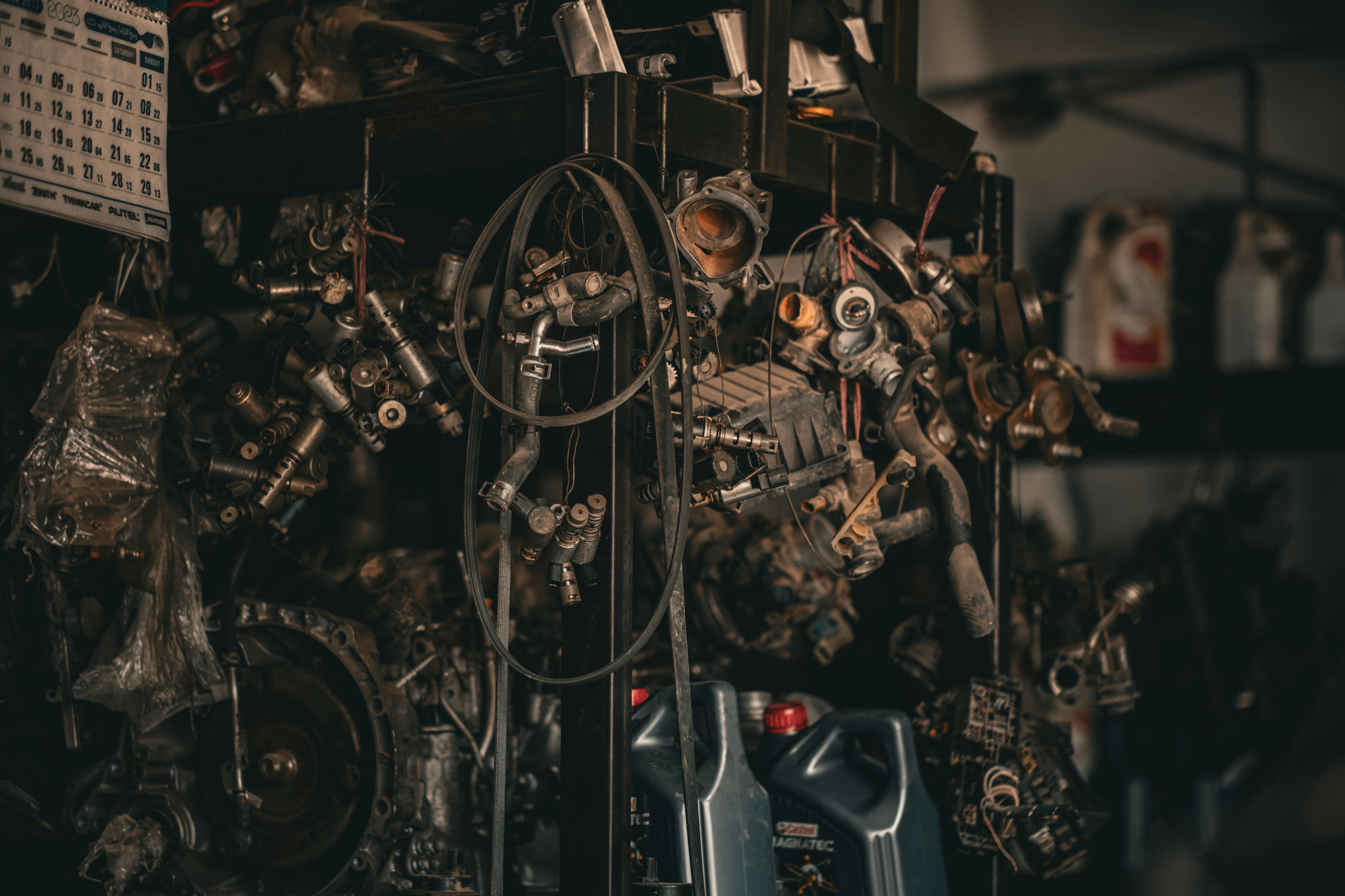 Busy Automobile Workshop: Mechanics at Work in a Garage · Free Stock Photo
