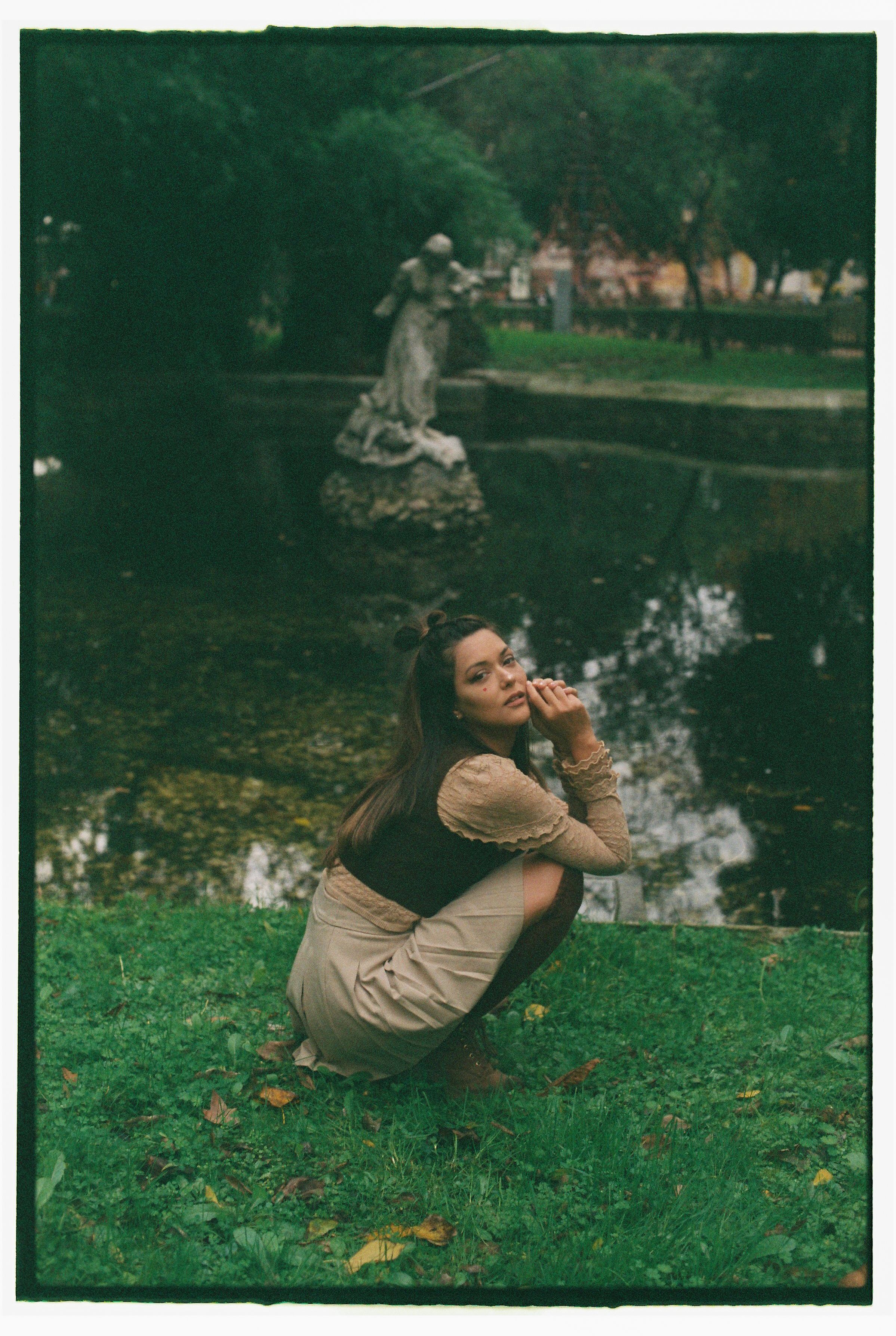Woman Sitting by the Stream in a Park · Free Stock Photo