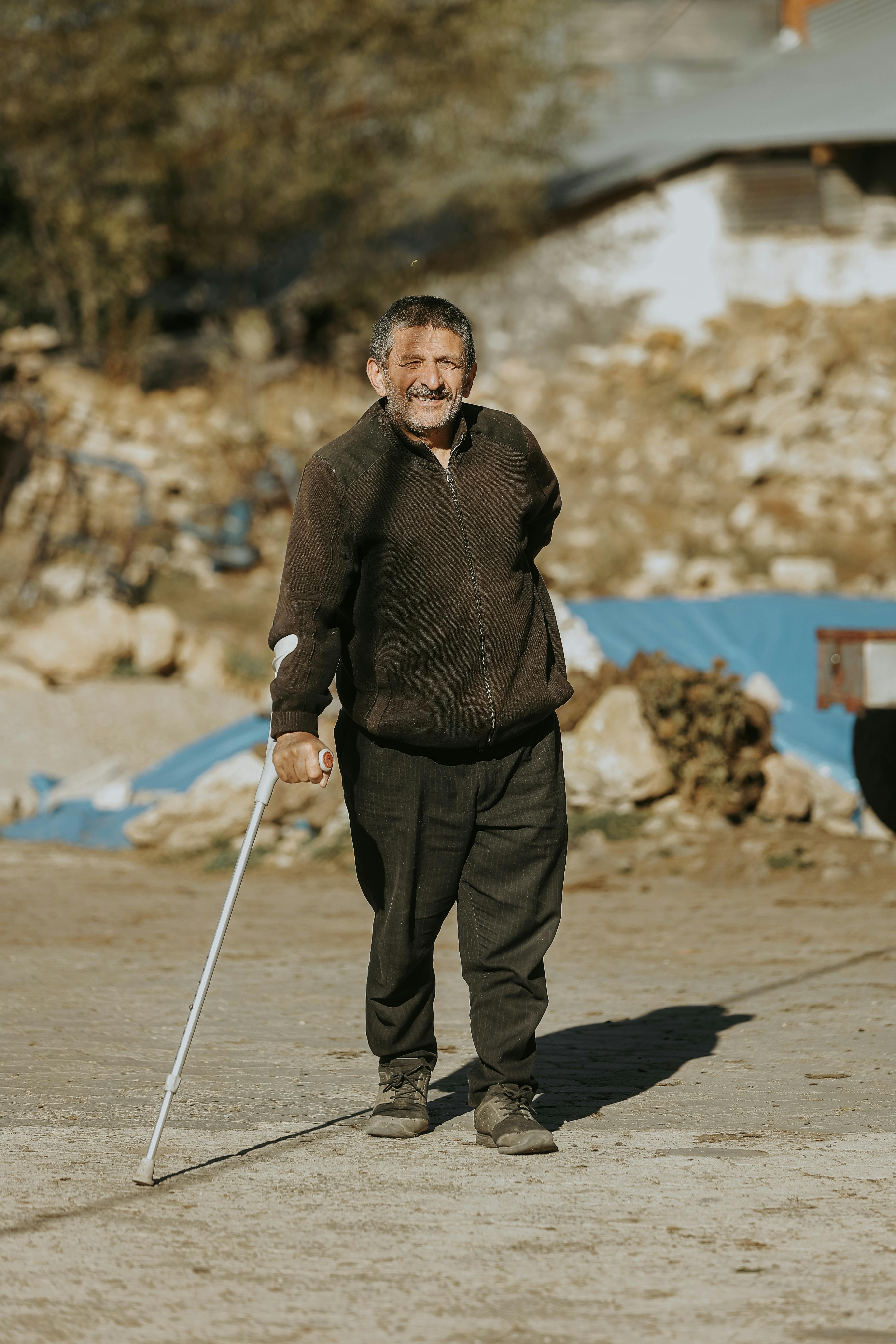 Smiling Man Using Cane · Free Stock Photo