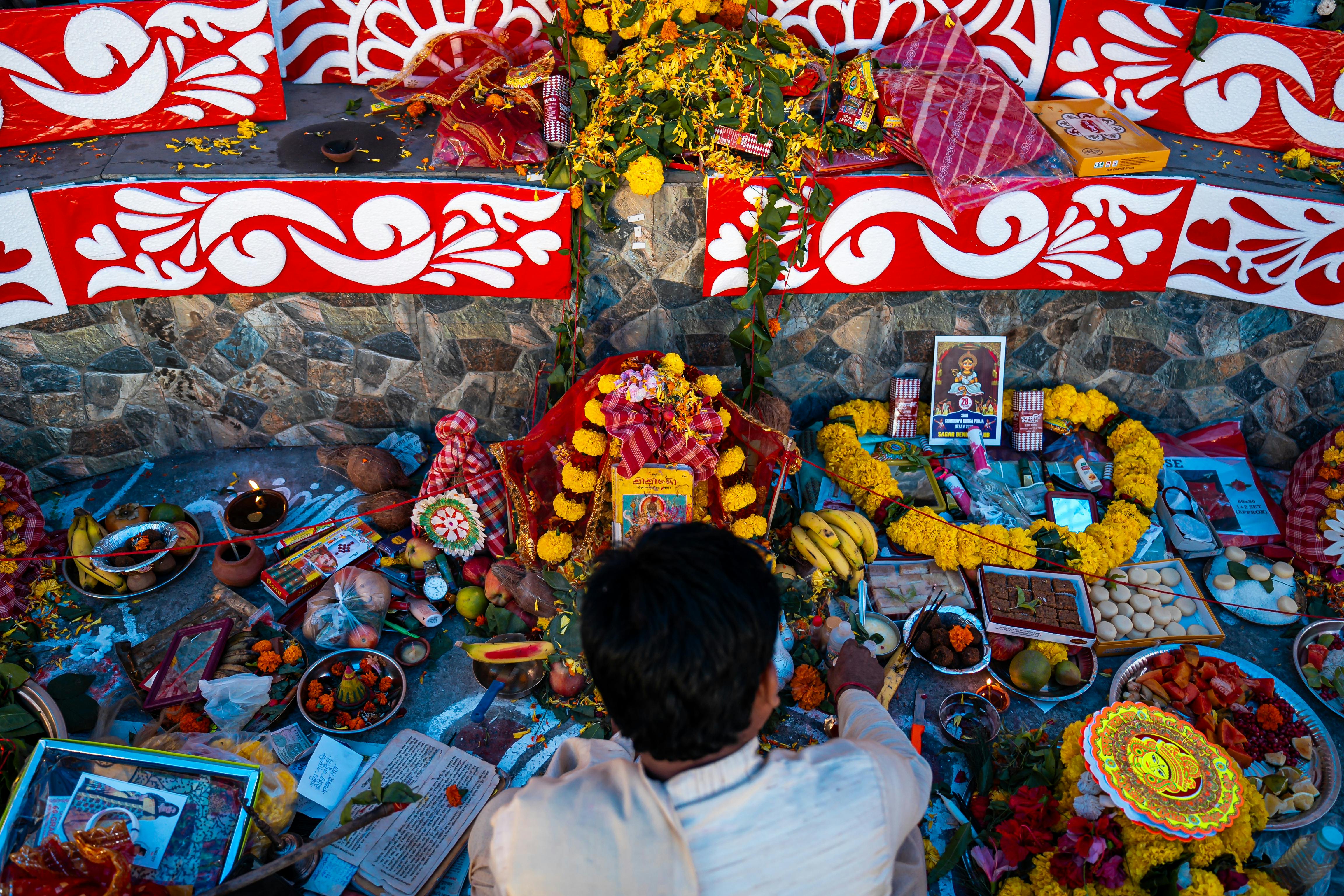 Man Praying at Buddhist Food Offering Altar · Free Stock Photo