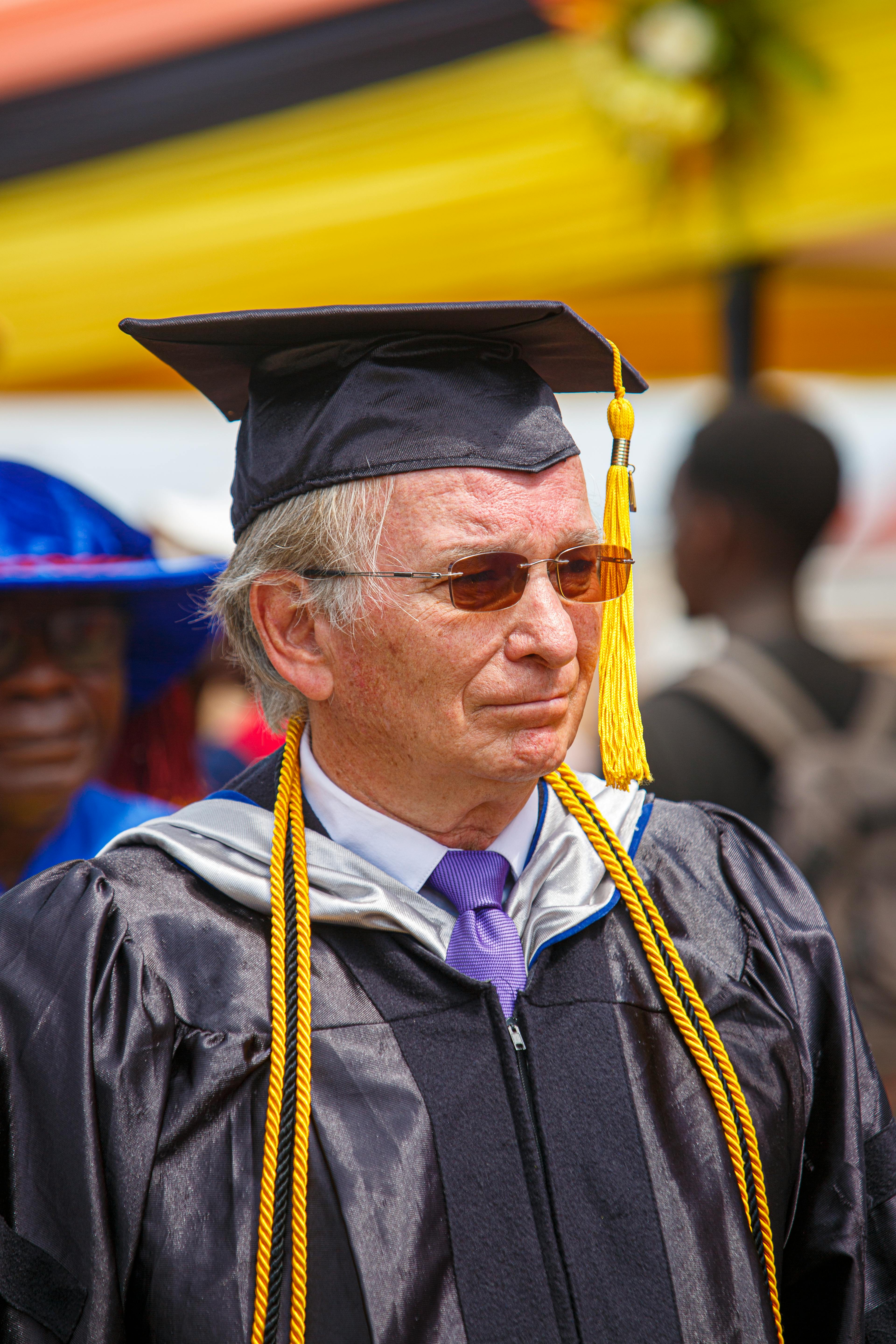 A Person Holding a Black Graduation Hat · Free Stock Photo