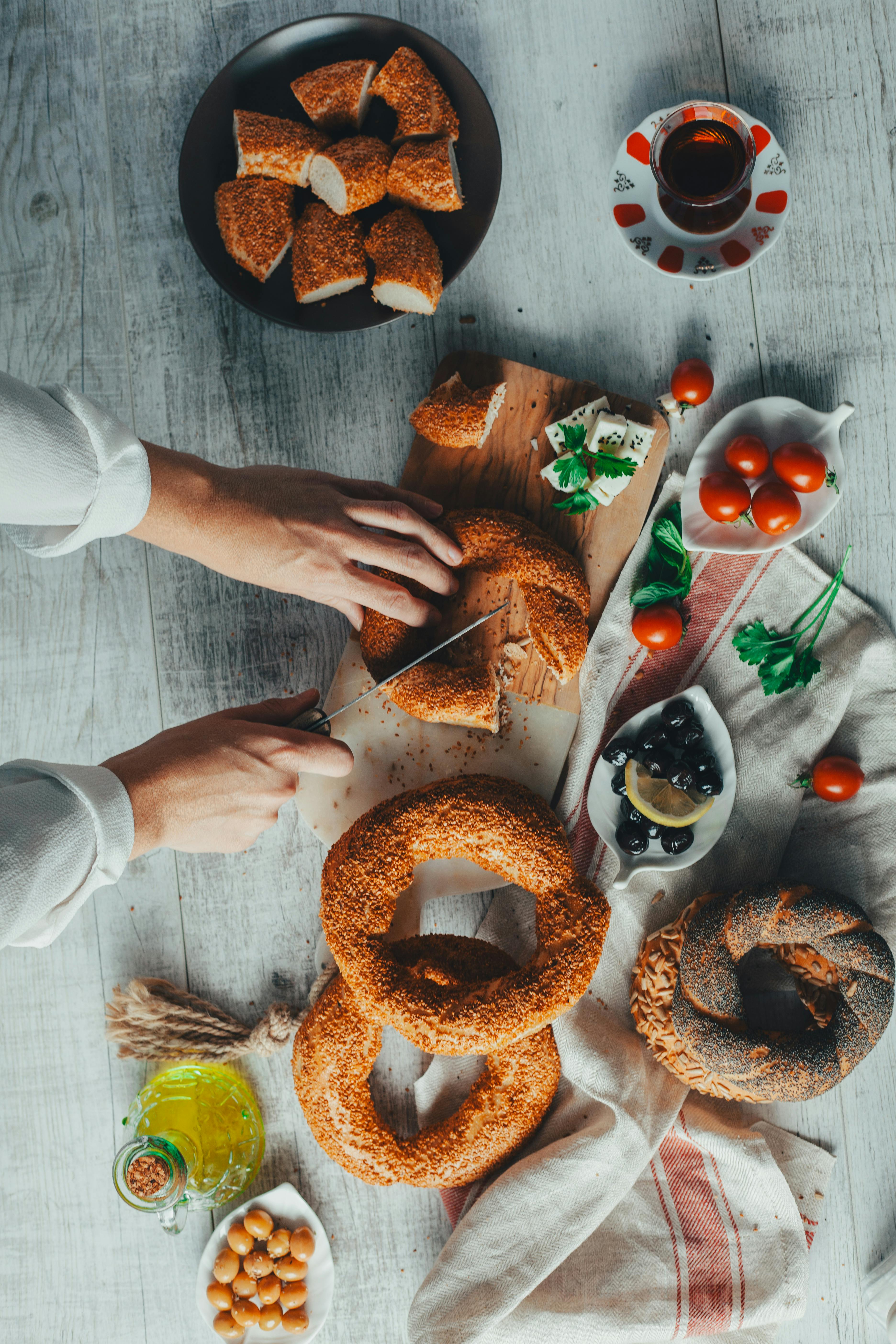 Woman Hands Cutting Simit for Breakfast · Free Stock Photo