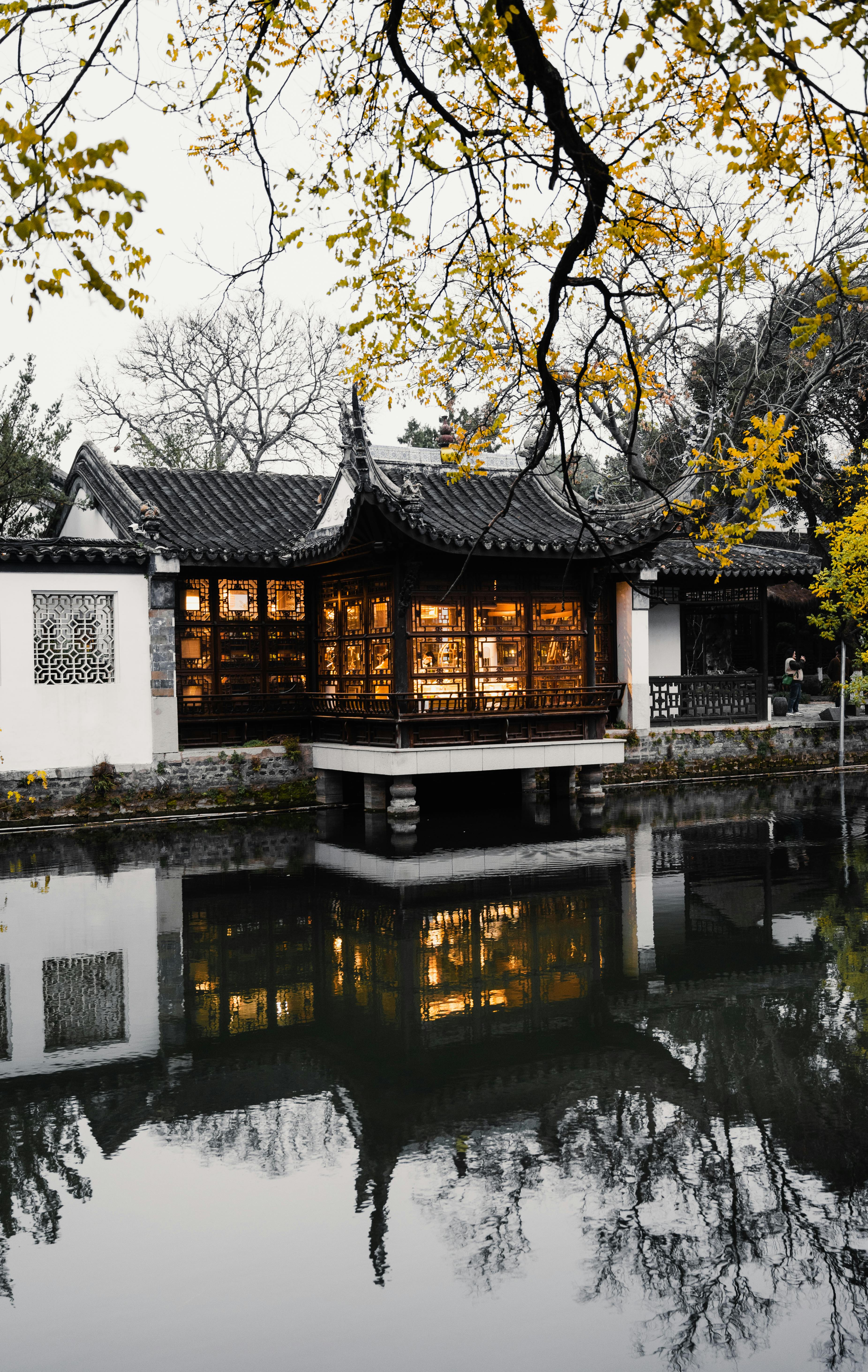 Traditional Building by Pond · Free Stock Photo