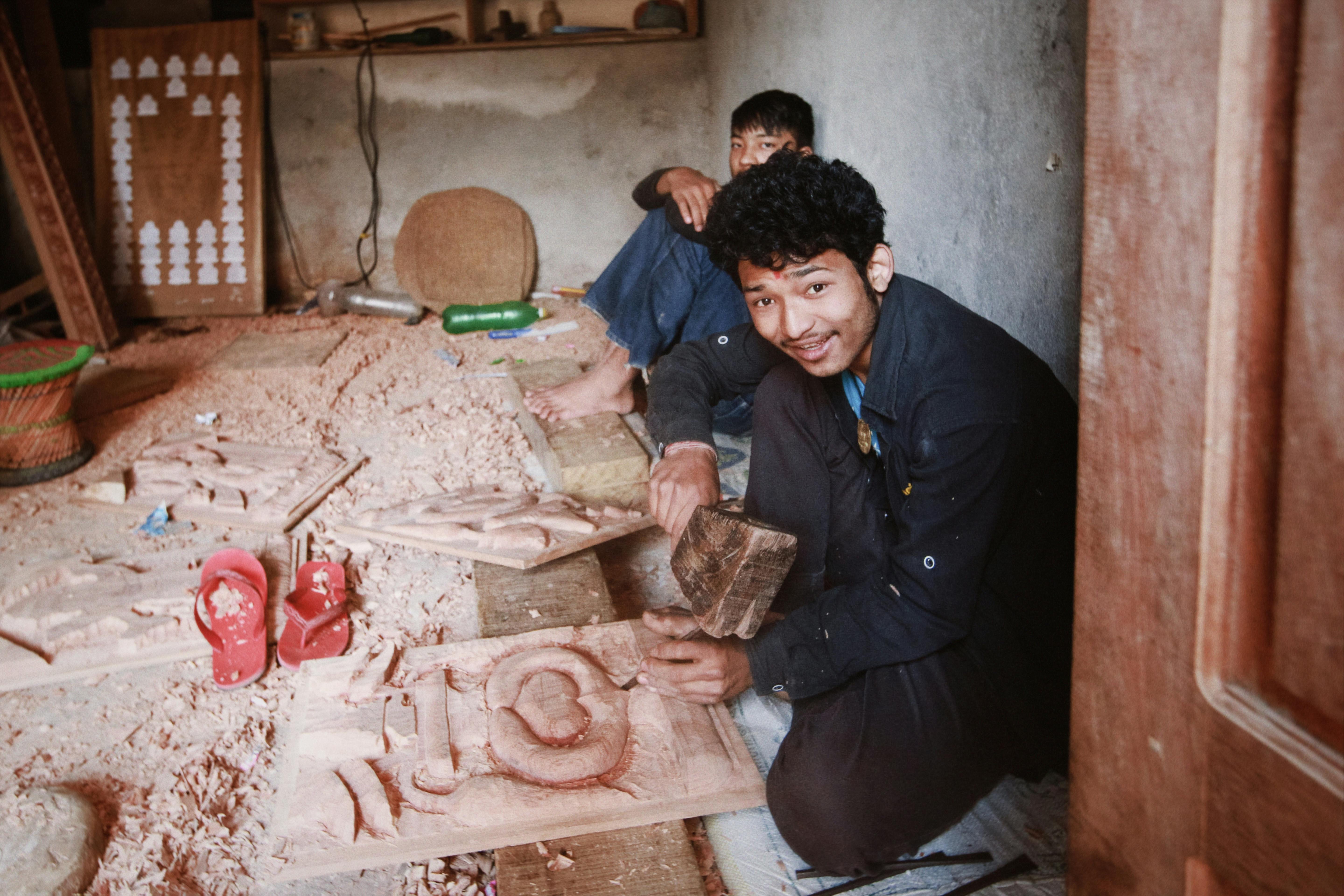 Young Men Carving in Wood · Free Stock Photo