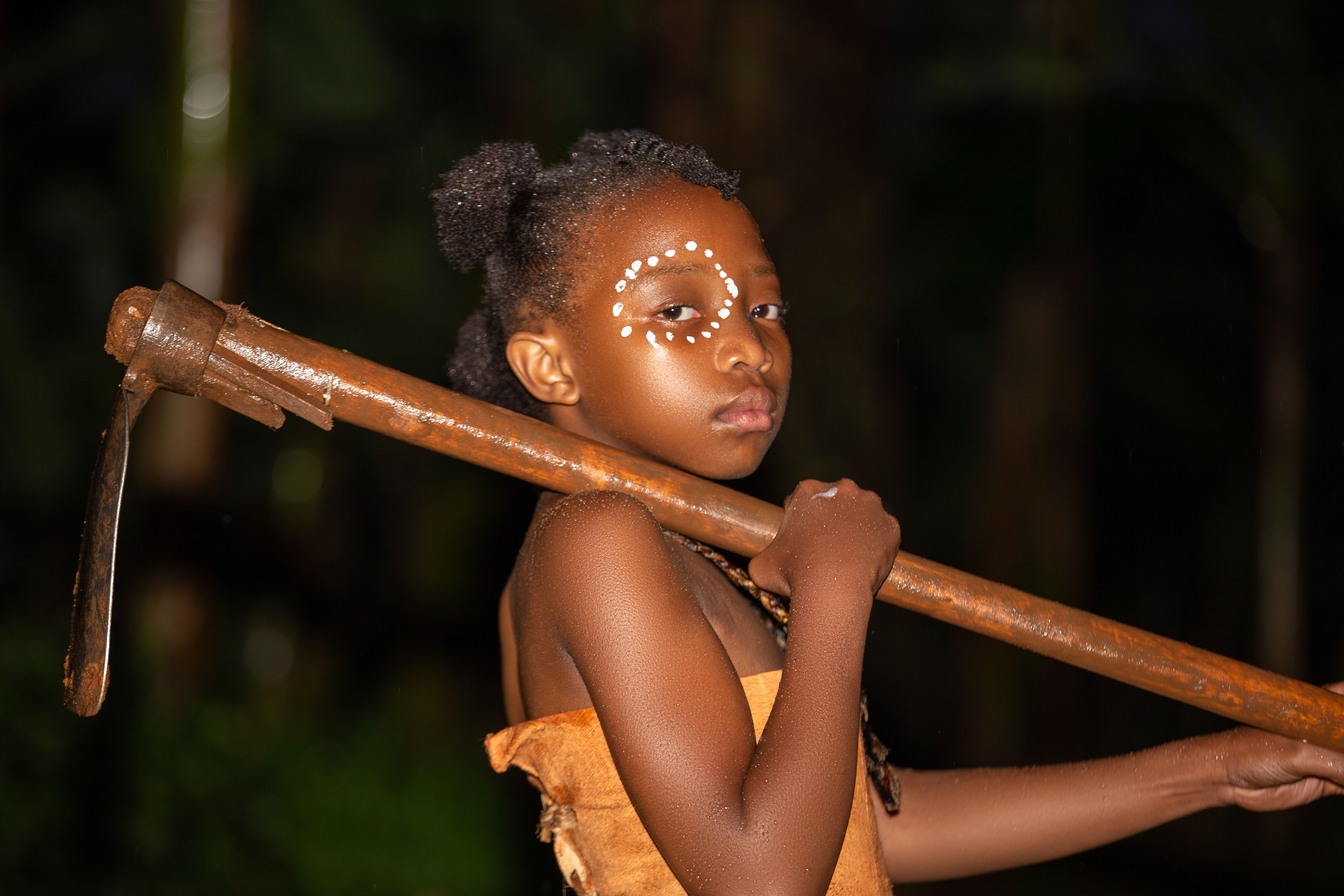 A Girl Standing Outside and Holding a Hoe over Her Shoulder · Free ...