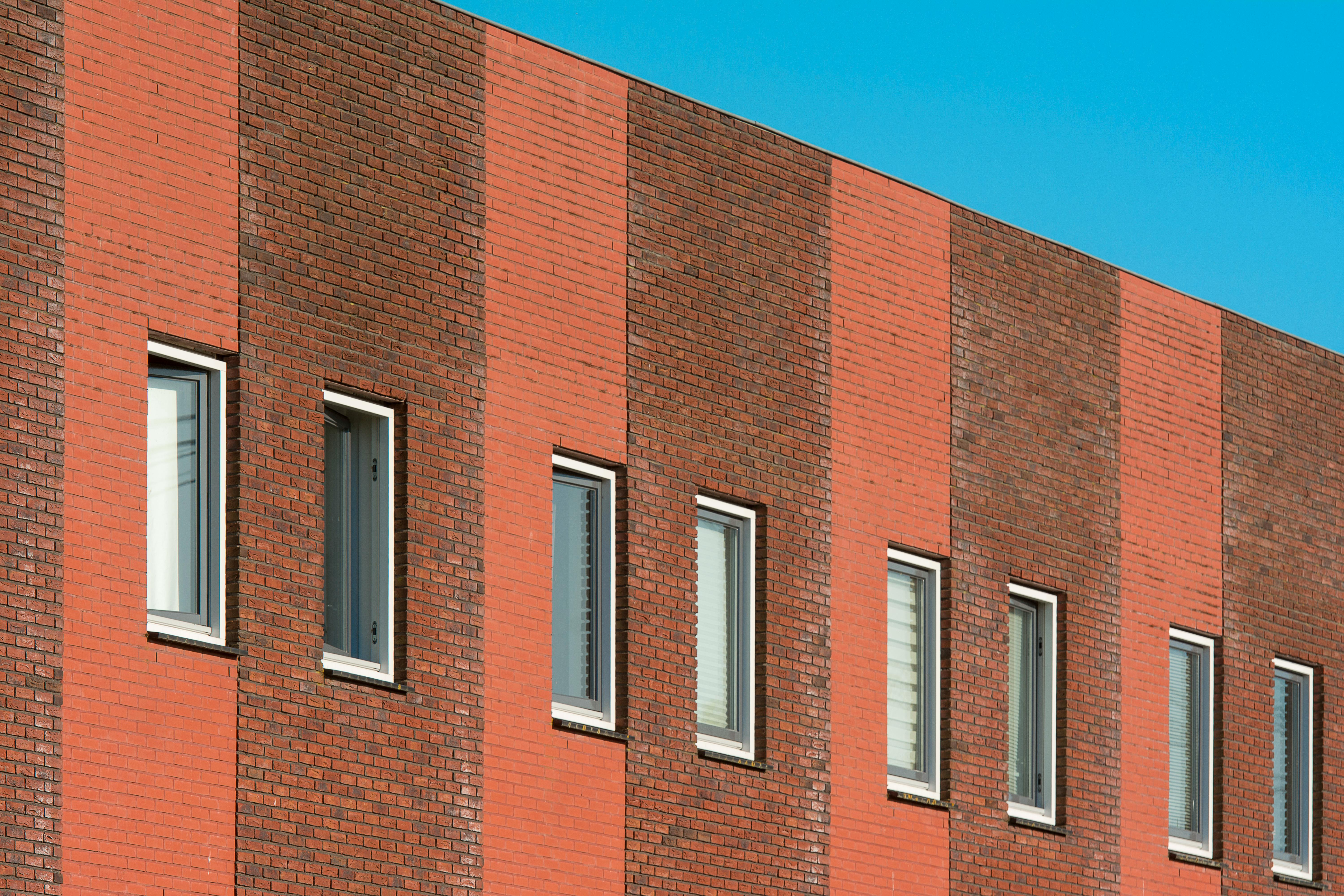 Red Brick Wall with Windows · Free Stock Photo
