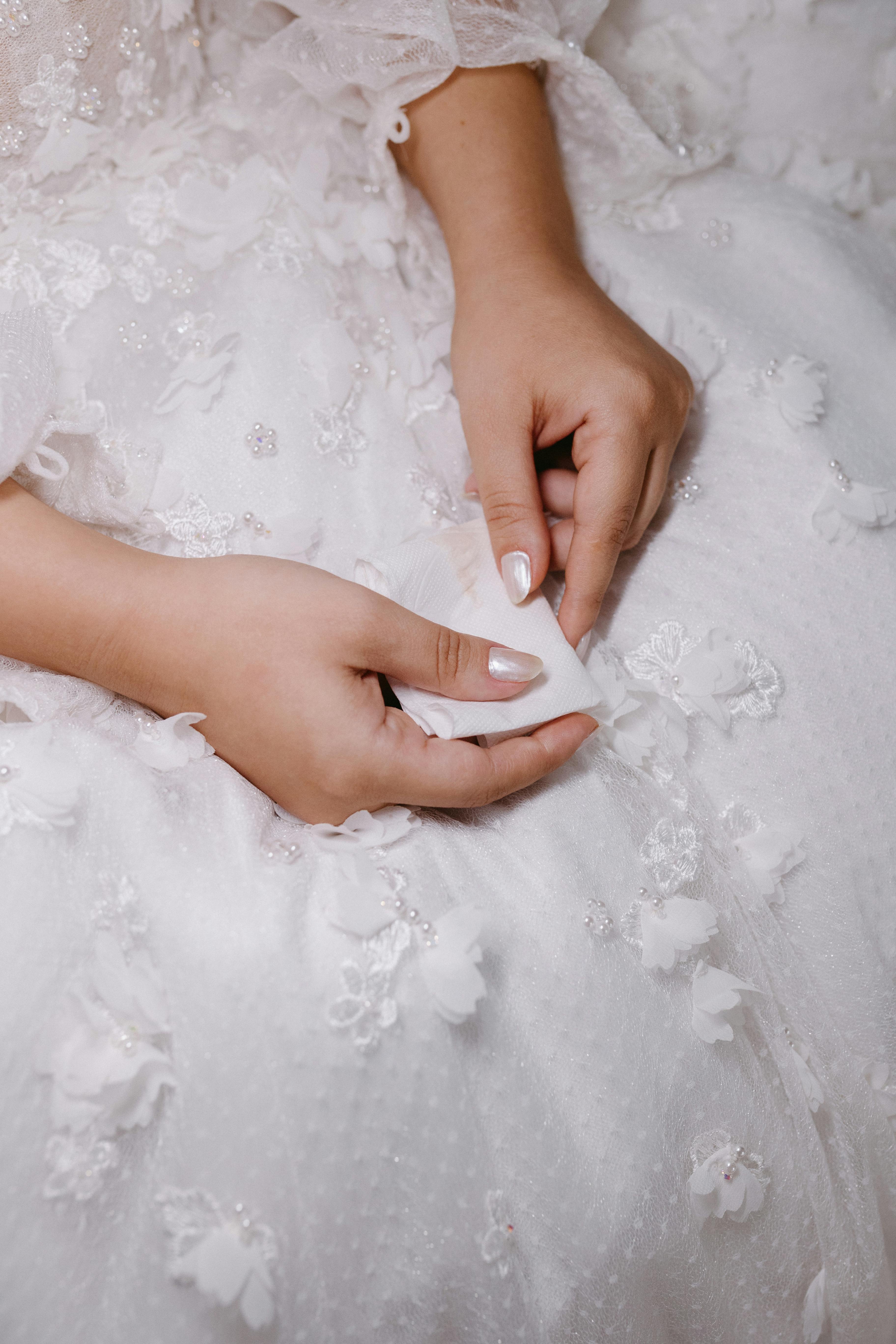 Hands of a Bride Clutching a Handkerchief · Free Stock Photo