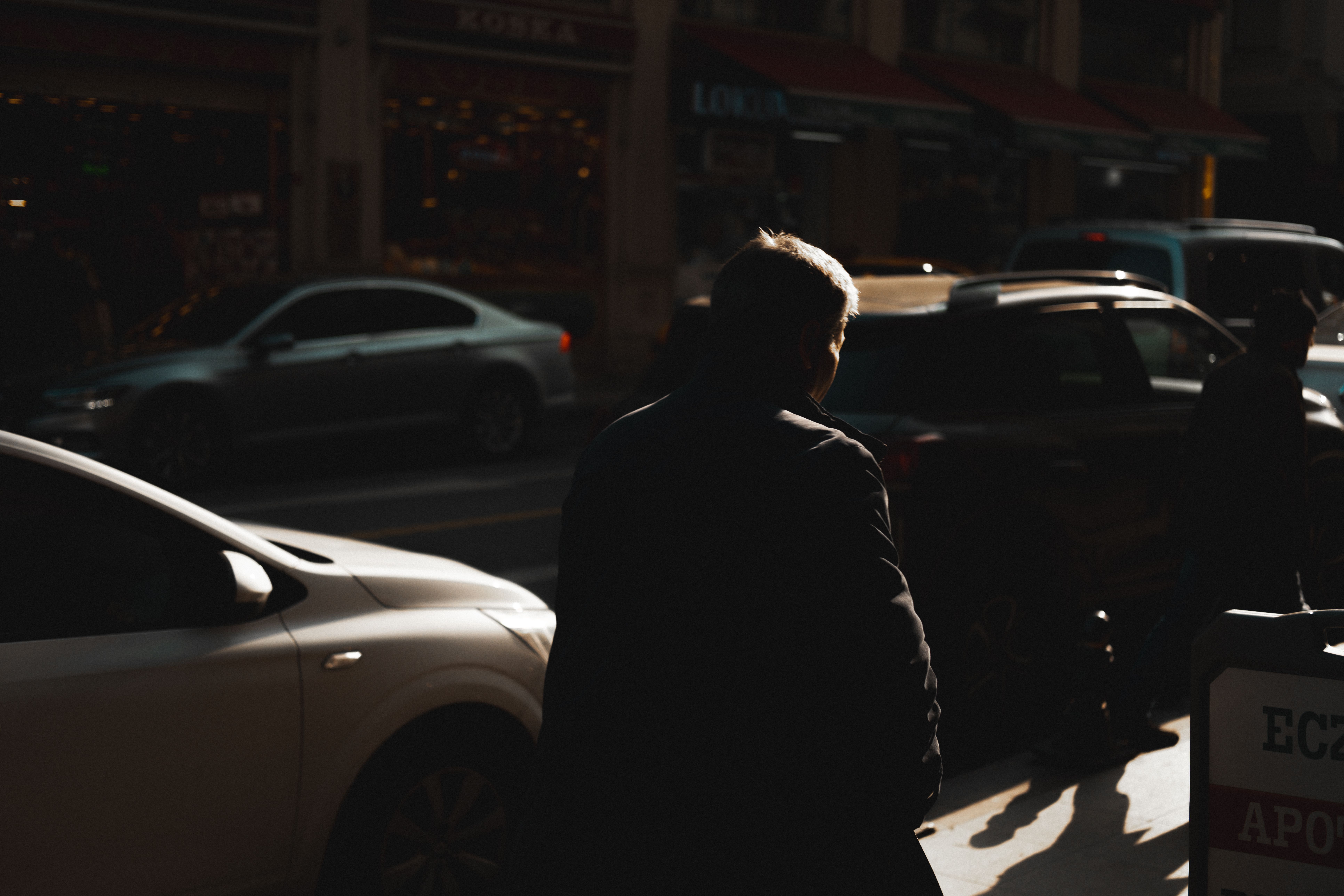 Man in Jacket Walking by Cars on Street · Free Stock Photo