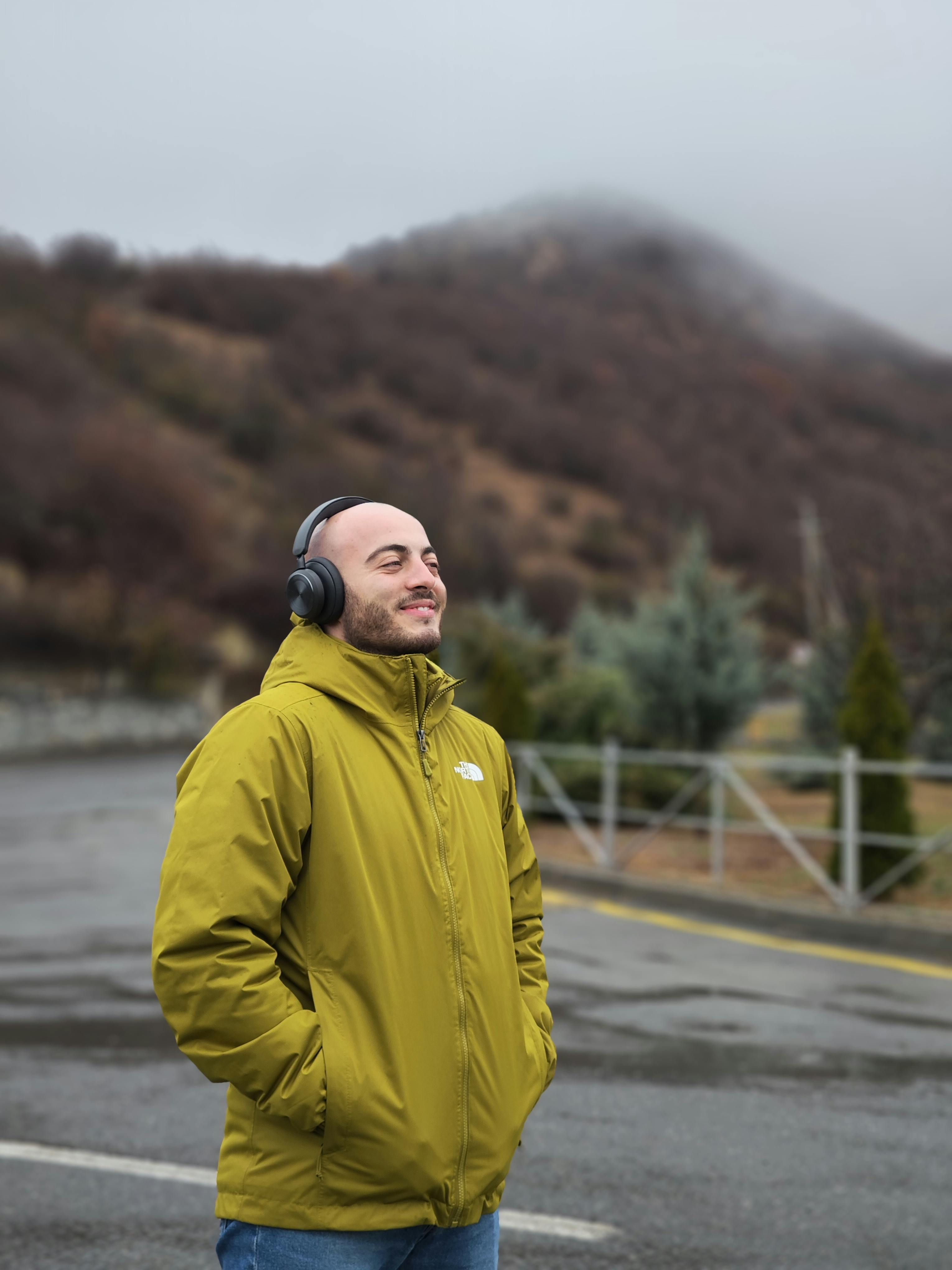 Man Wearing Yellow Jacket on a Road in Valley · Free Stock Photo