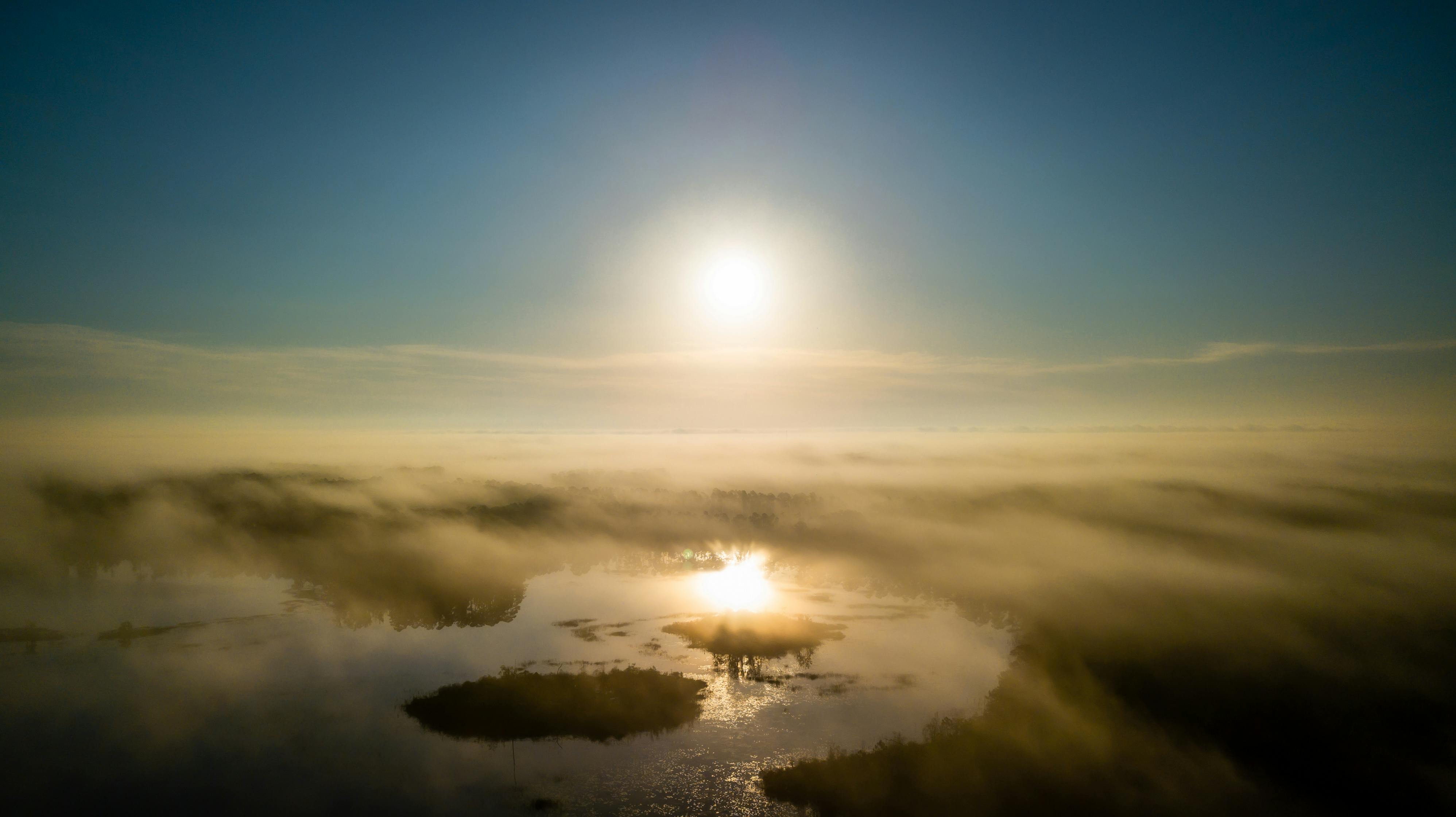 Sun over Clouds on Sky over Lake · Free Stock Photo