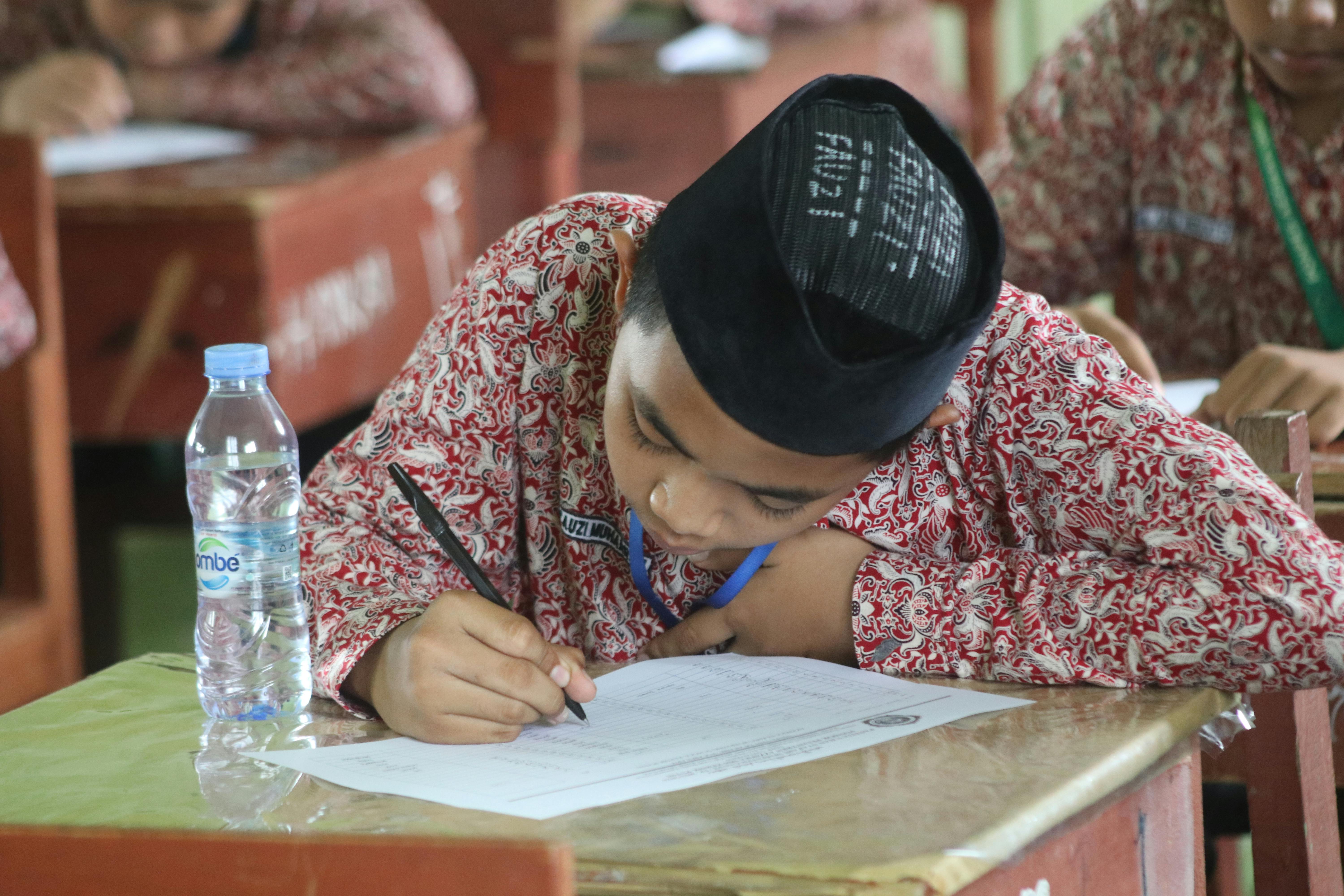 A Boy Taking a Test at School · Free Stock Photo