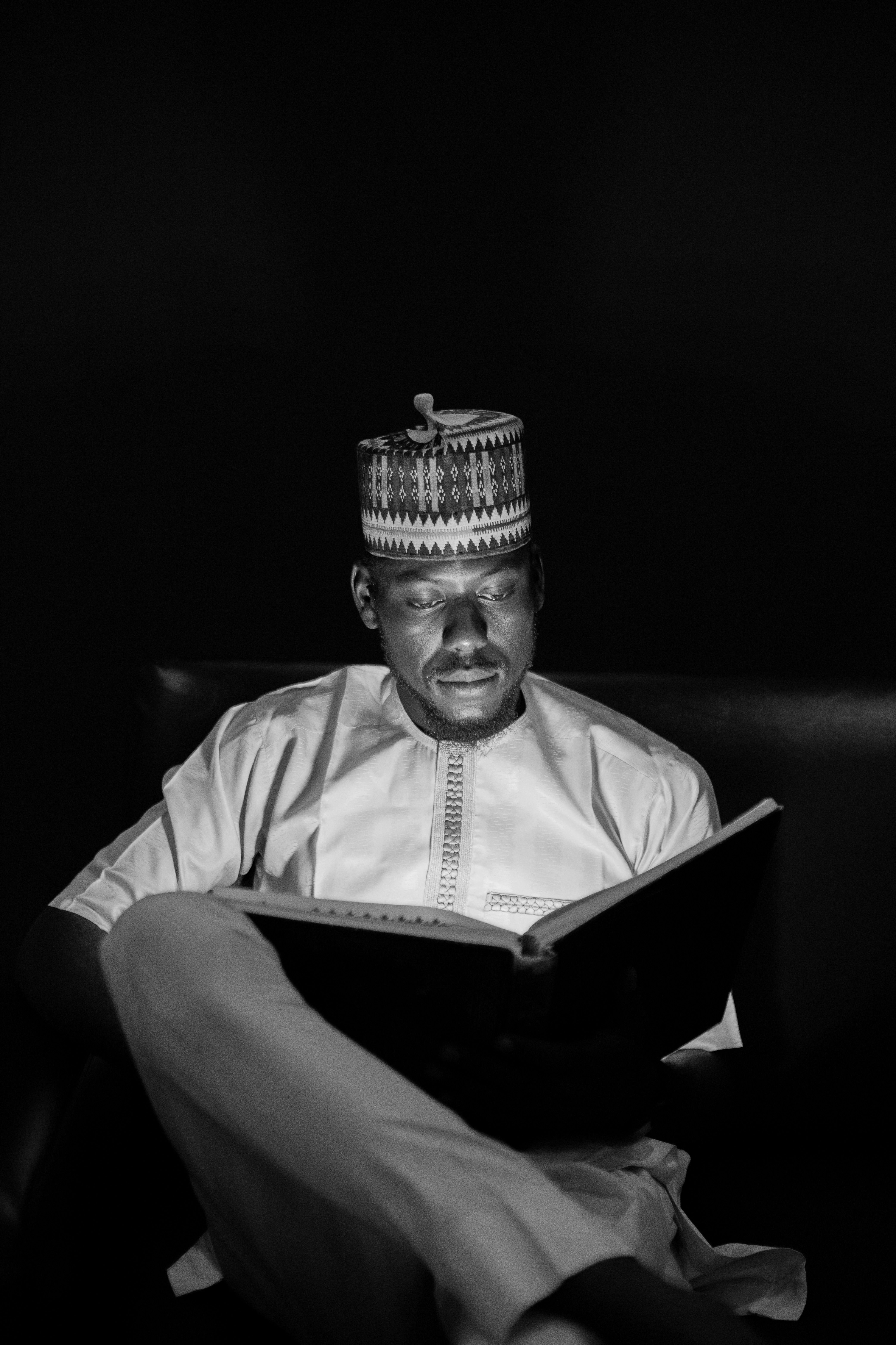 Man Wearing Traditional Hat Reading a Book in Black and White · Free ...