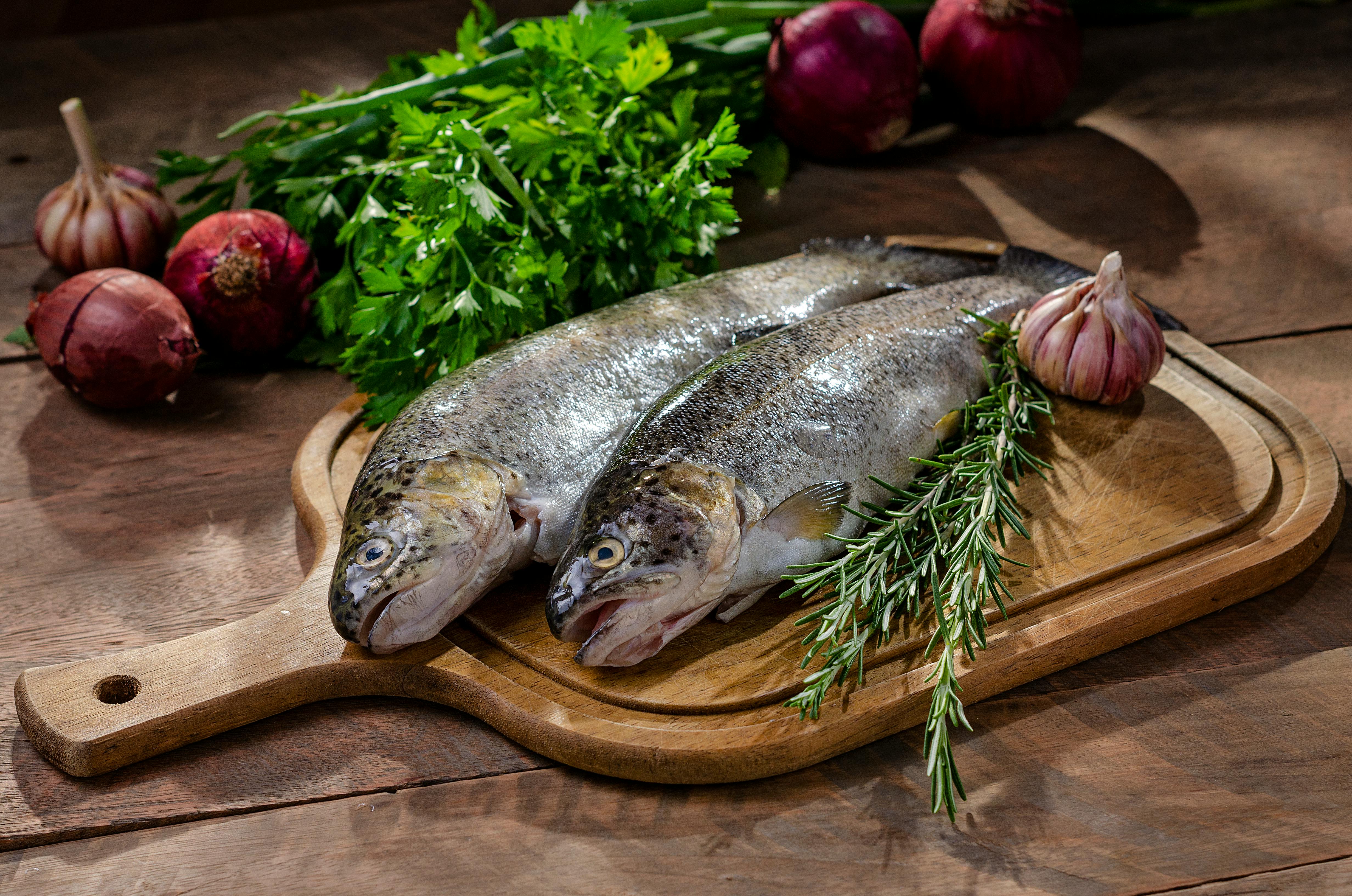 Two Fresh Fish among other Ingredients · Free Stock Photo