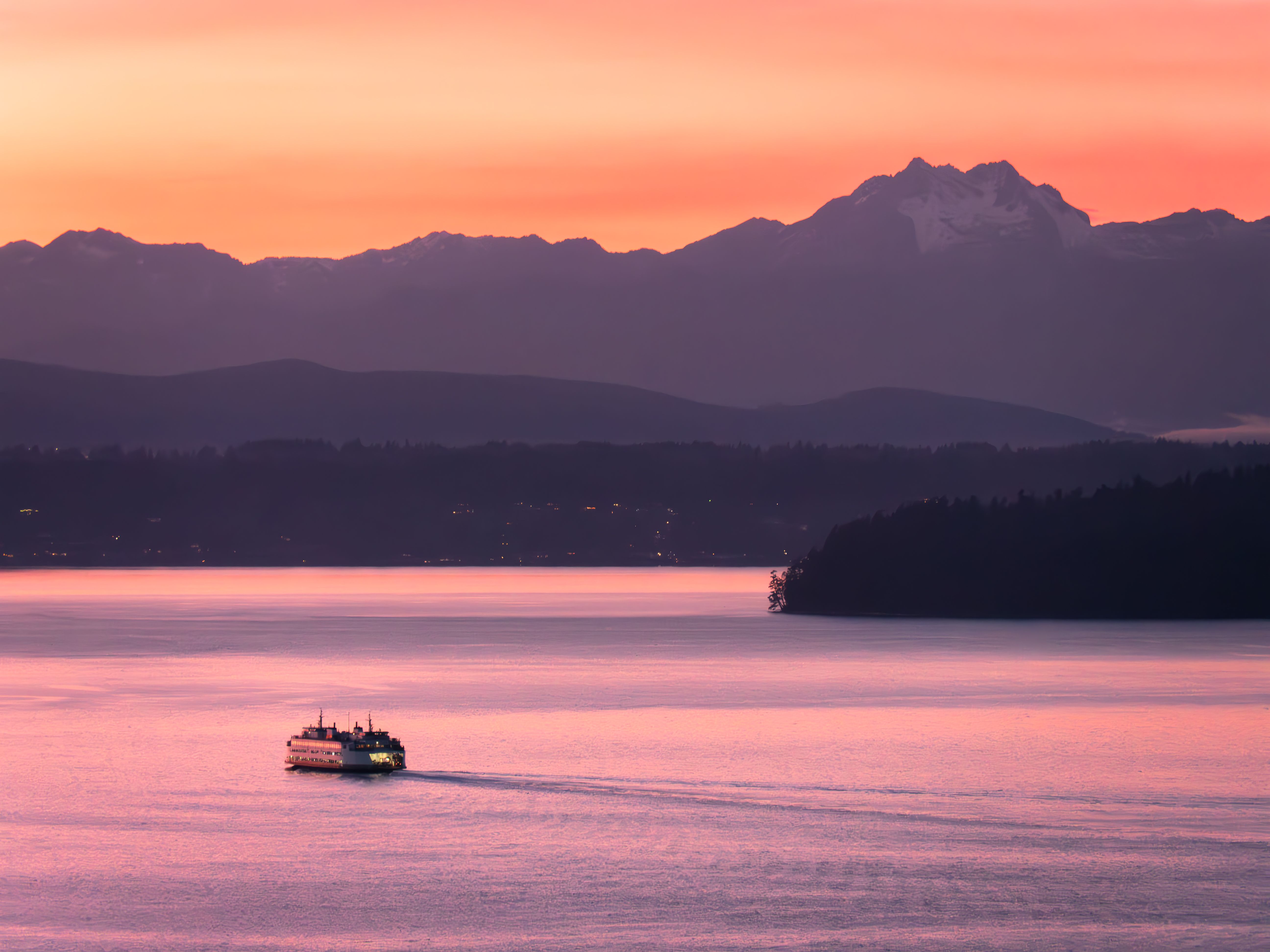 A boat traveling across the water at sunset · Free Stock Photo
