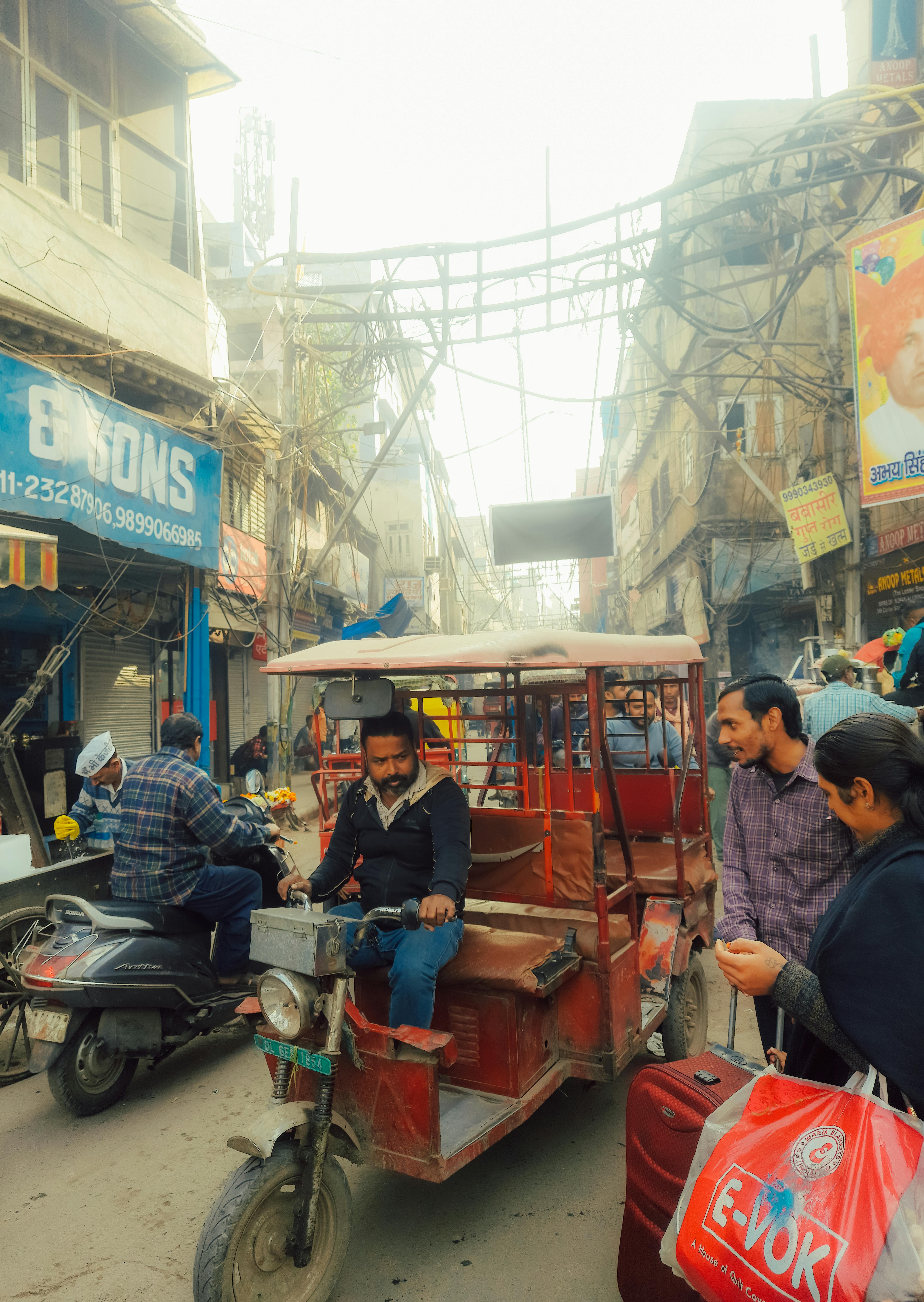 Men Walking on Street with Auto Rickshaws behind · Free Stock Photo