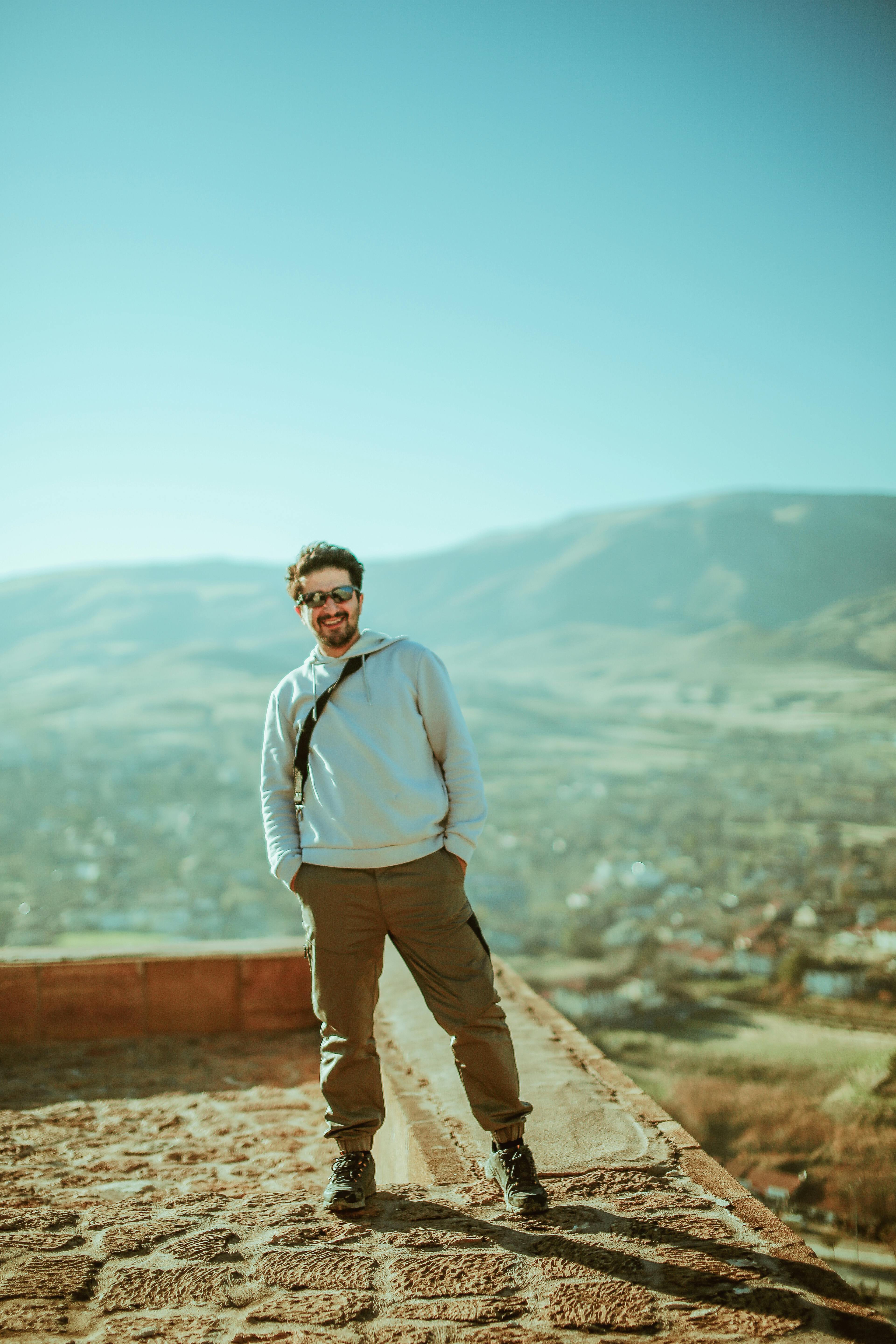 Man on a Hill in a Valley · Free Stock Photo