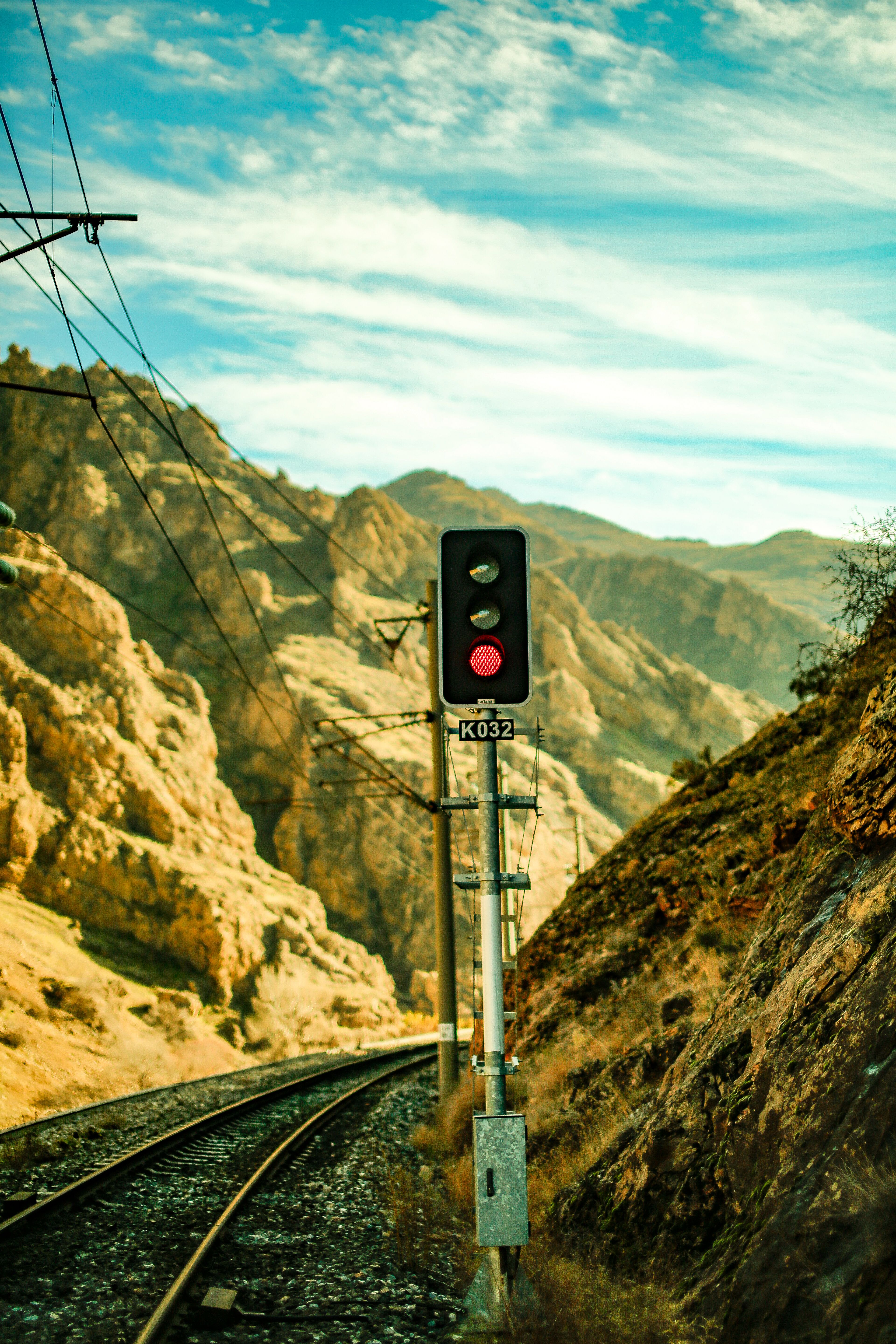 Railway Tracks with a Red Stop Sign in a Valley · Free Stock Photo
