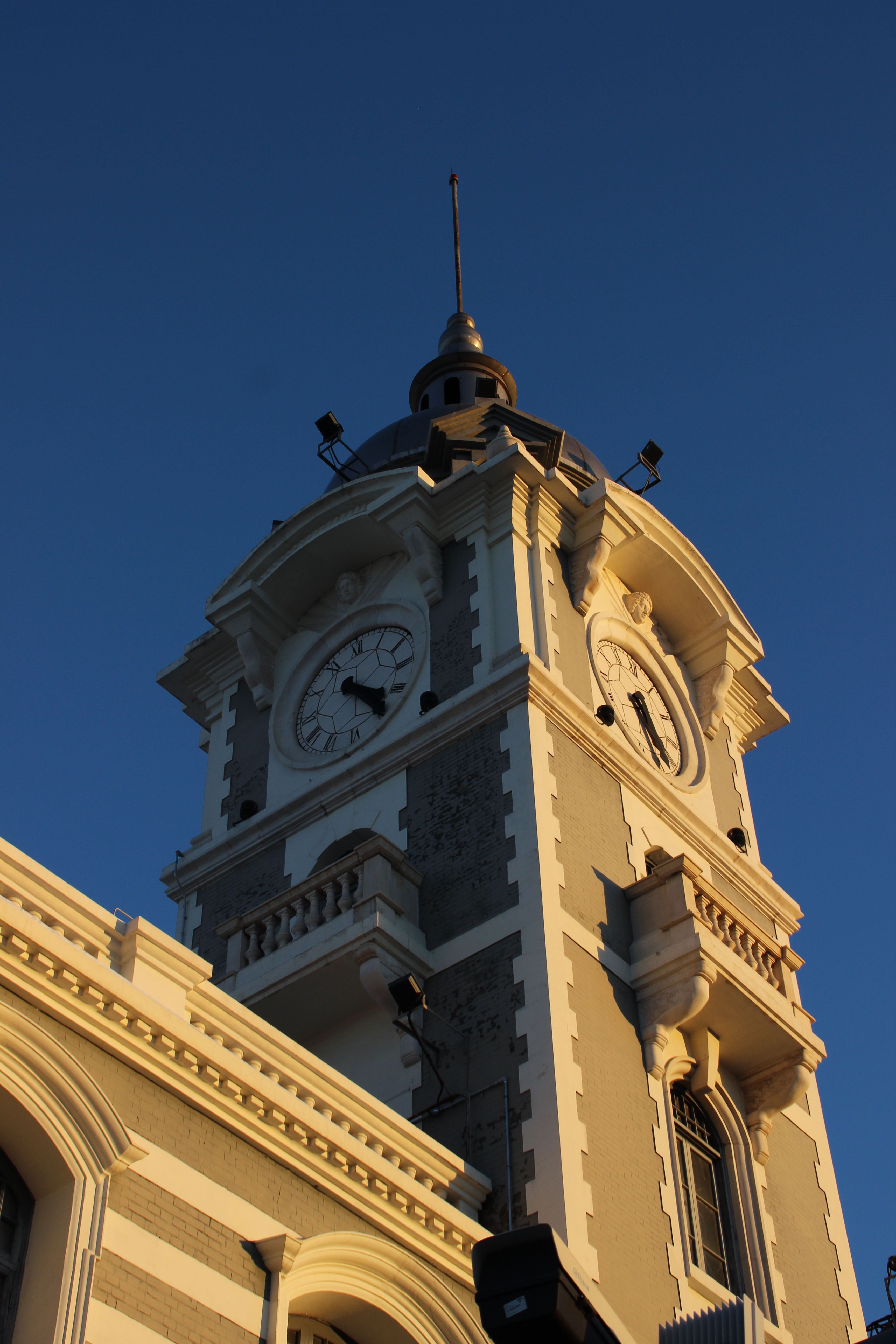Close-up Photo of Street Clock Near Tall Building · Free Stock Photo