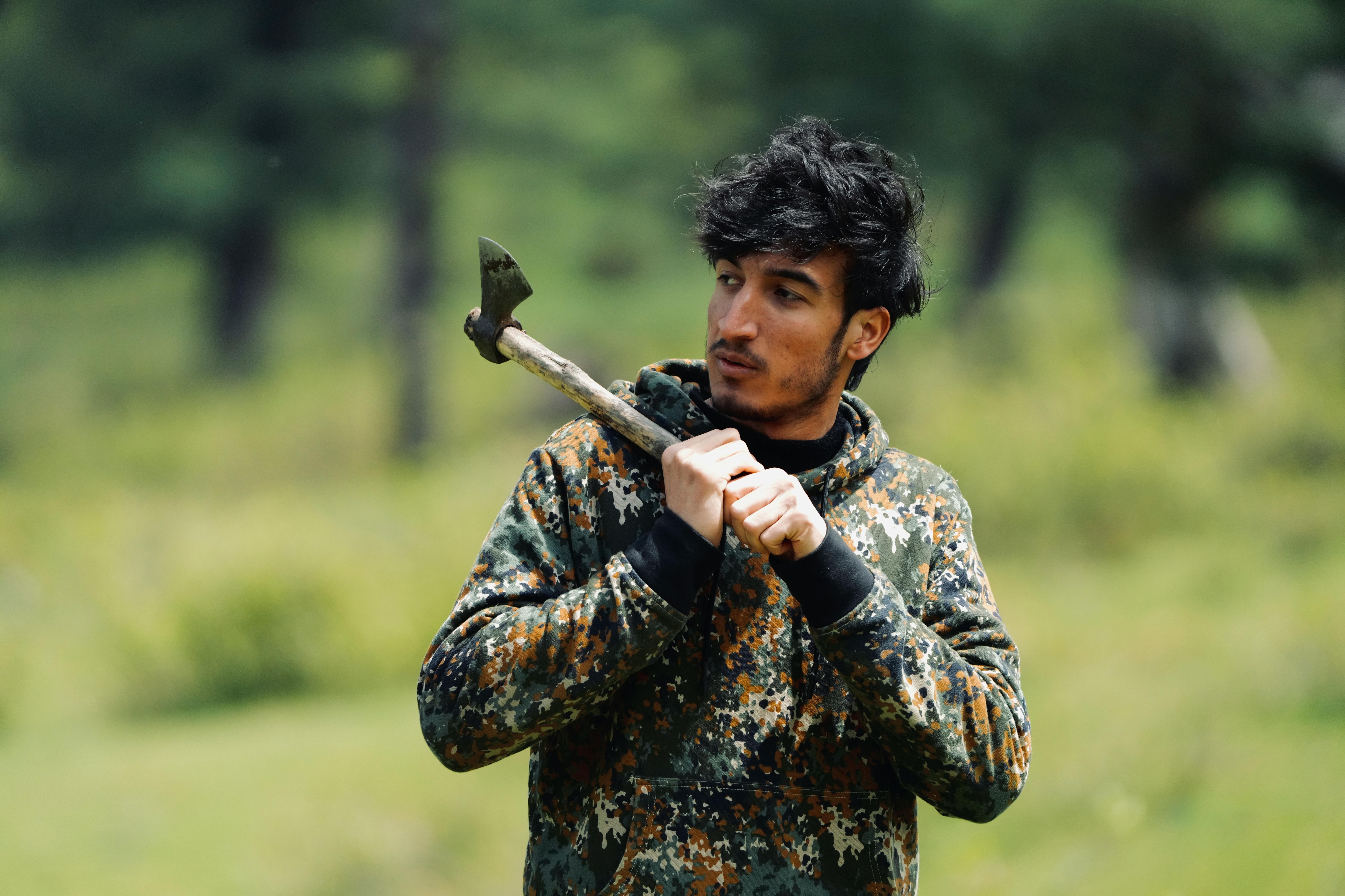 A Man Standing Outside and Holding an Axe · Free Stock Photo