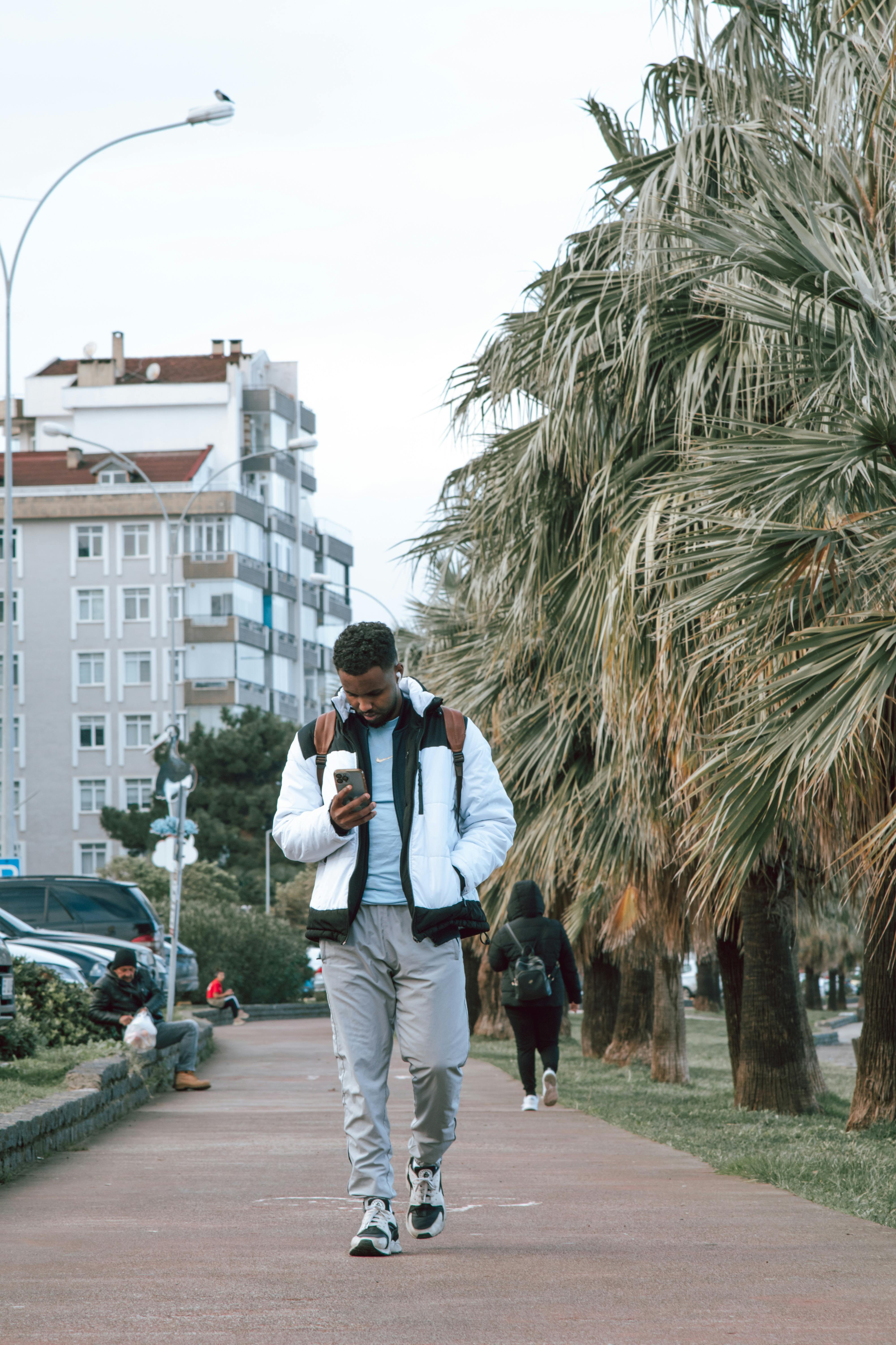 Man Walking on Sidewalk · Free Stock Photo