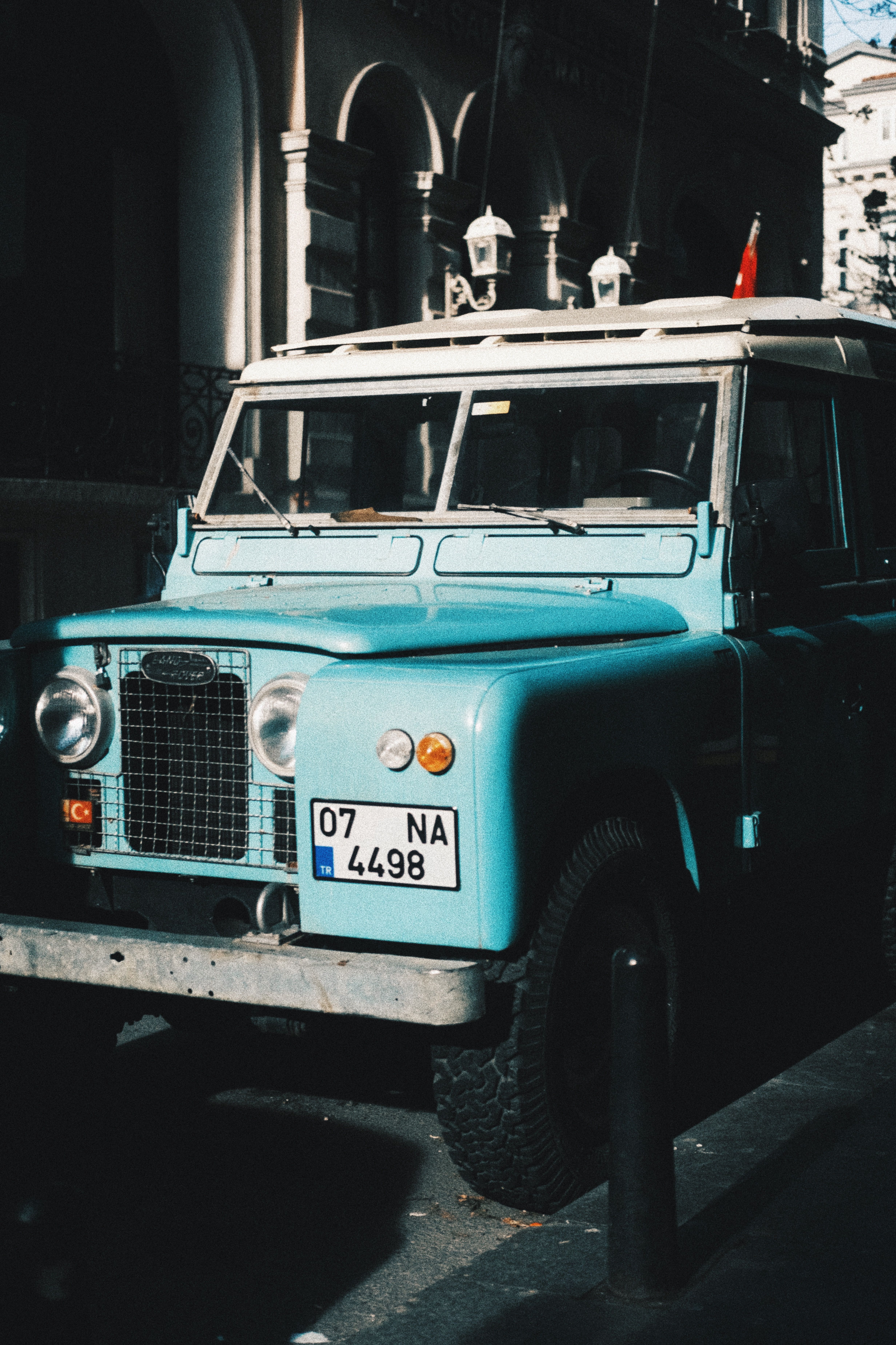 Classic Blue Car Parked Near Fence and Trees · Free Stock Photo