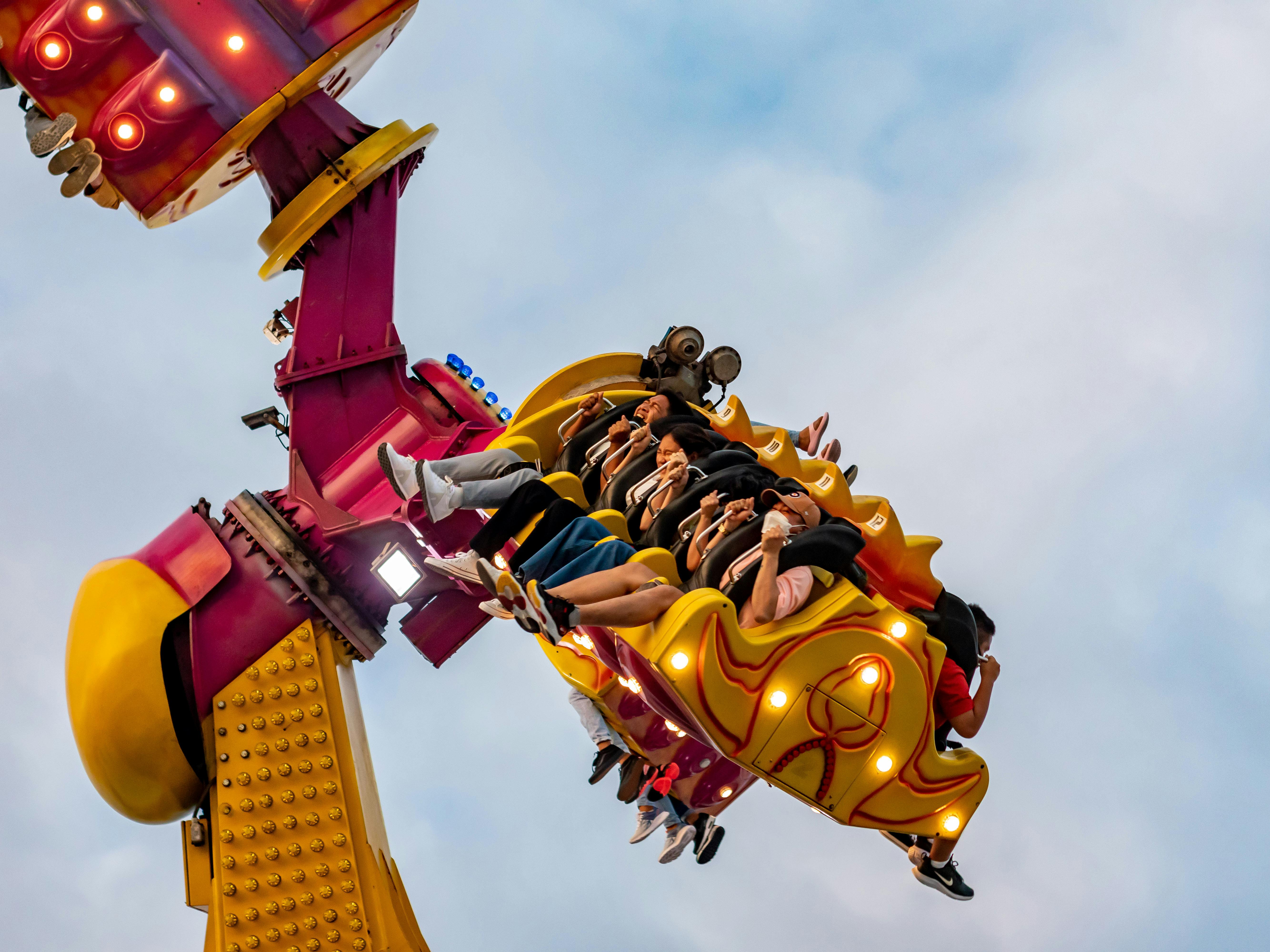 People Riding on White and Red Carnival Rides · Free Stock Photo